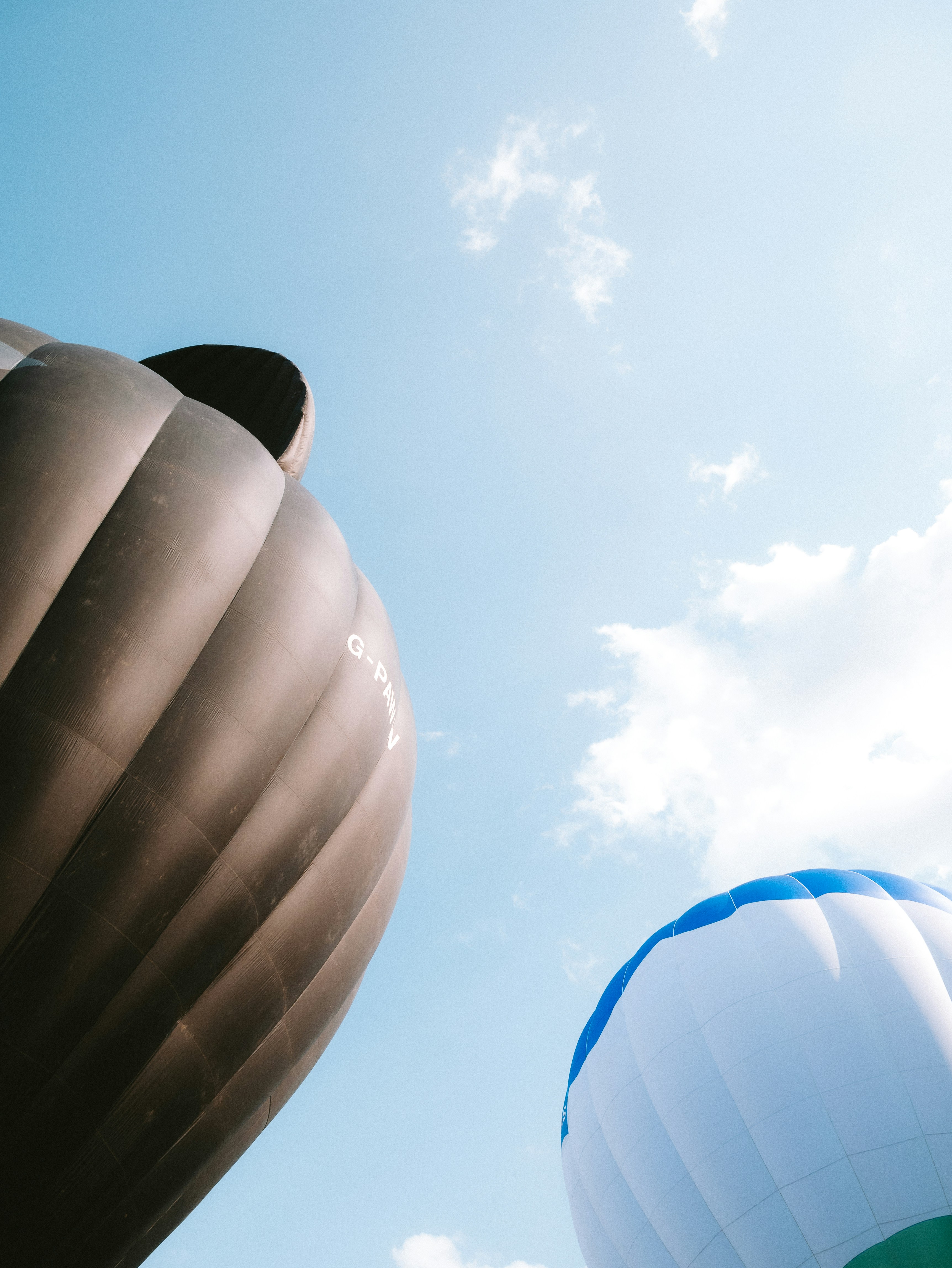 Ballooned Ground: Upward View of Floating Sails Against a Clear Sky
