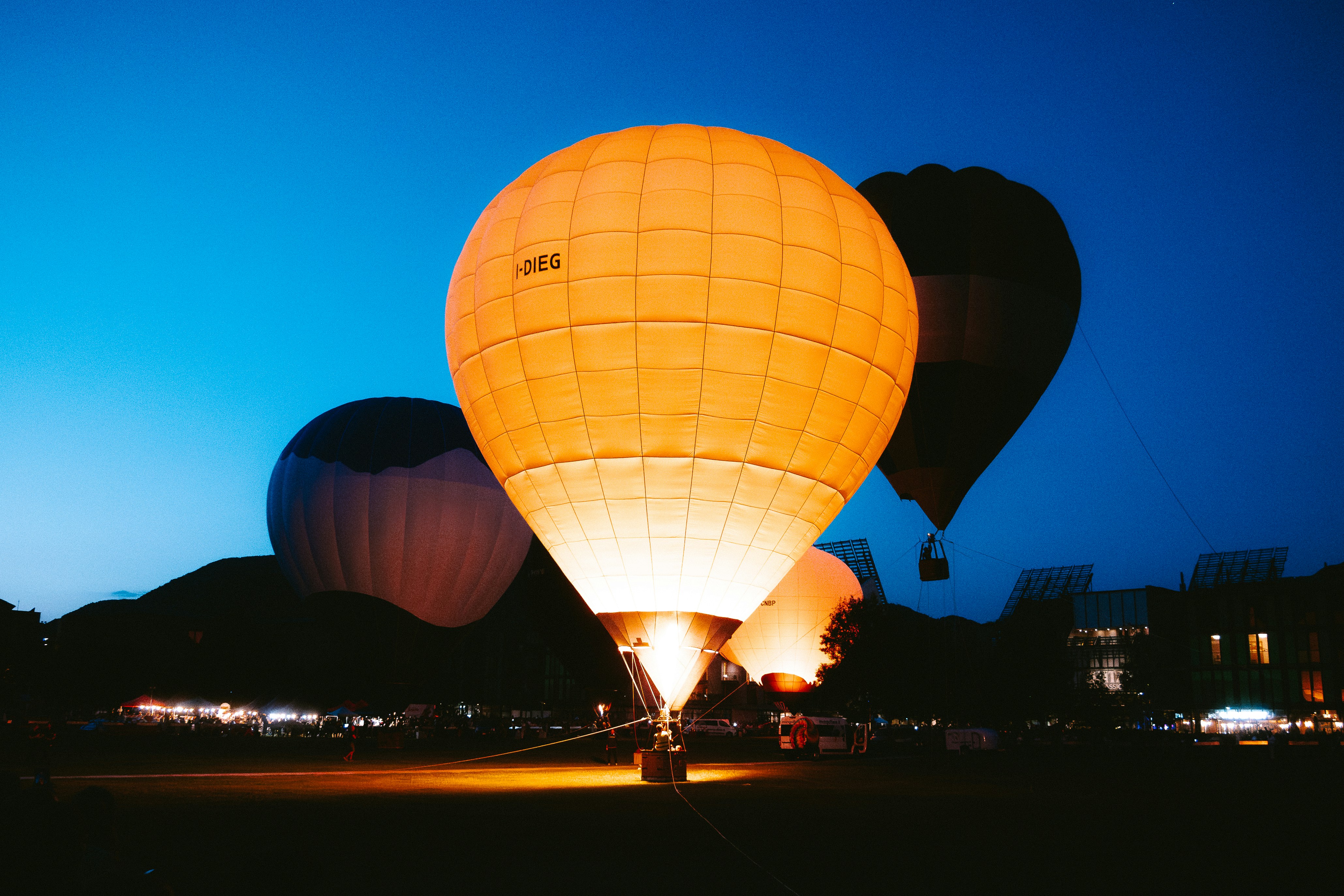 Central Burst: A glowing hot air balloon anchors the night lit field