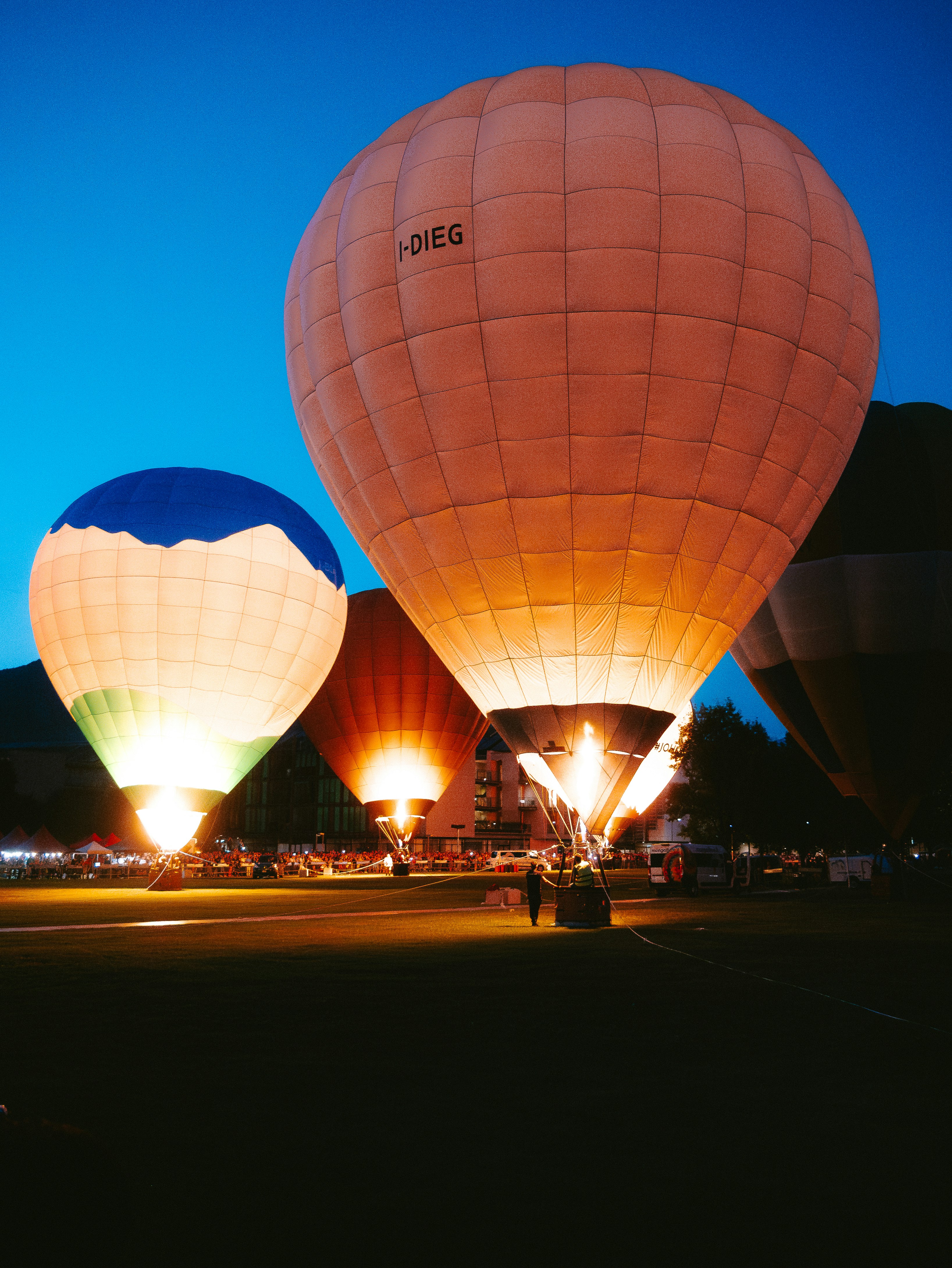 Balloon Ignition: Night Glow Over a Field of Lifted Sails