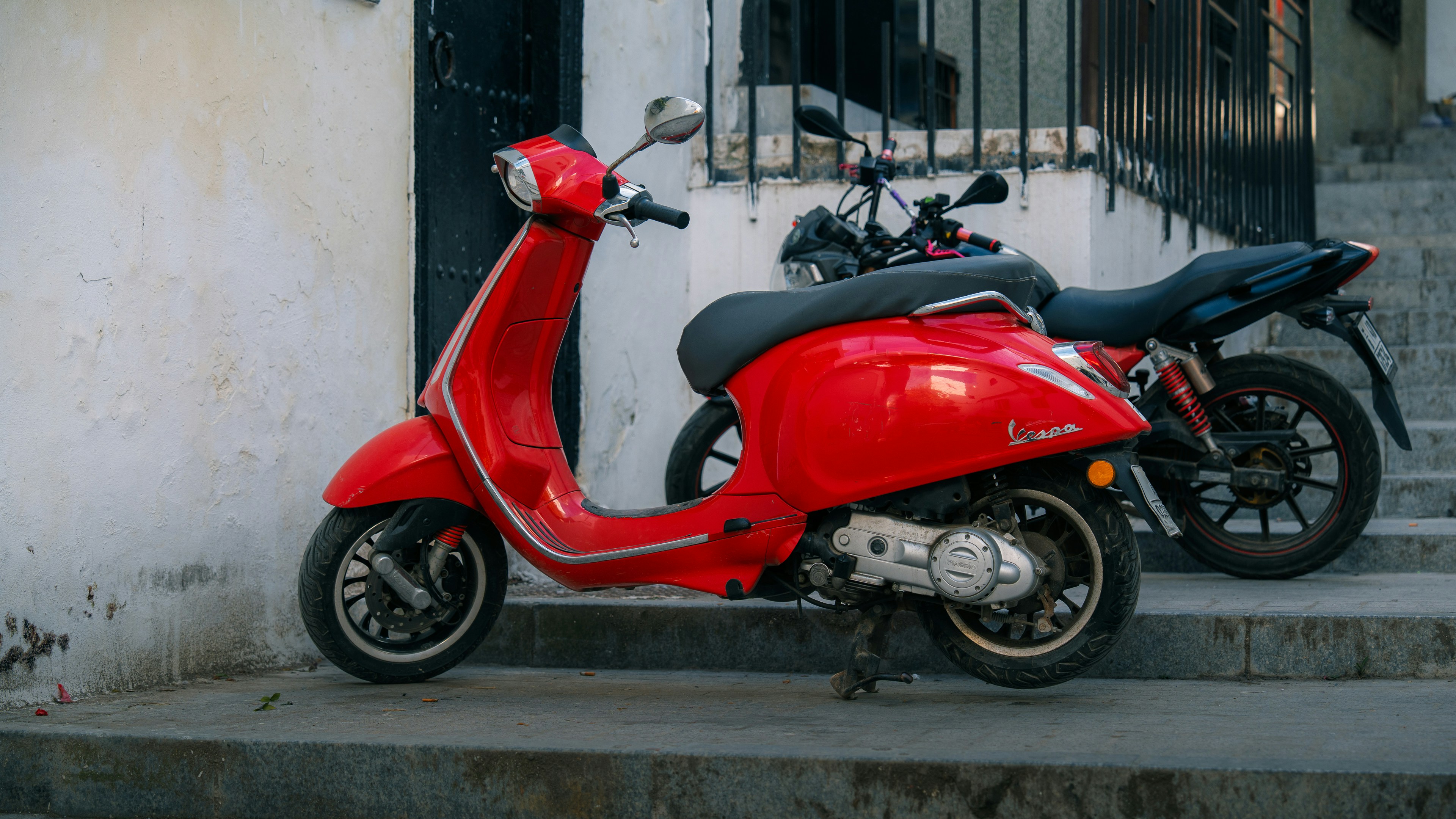 Crimson Commuter: A Red Vespa by the Steps