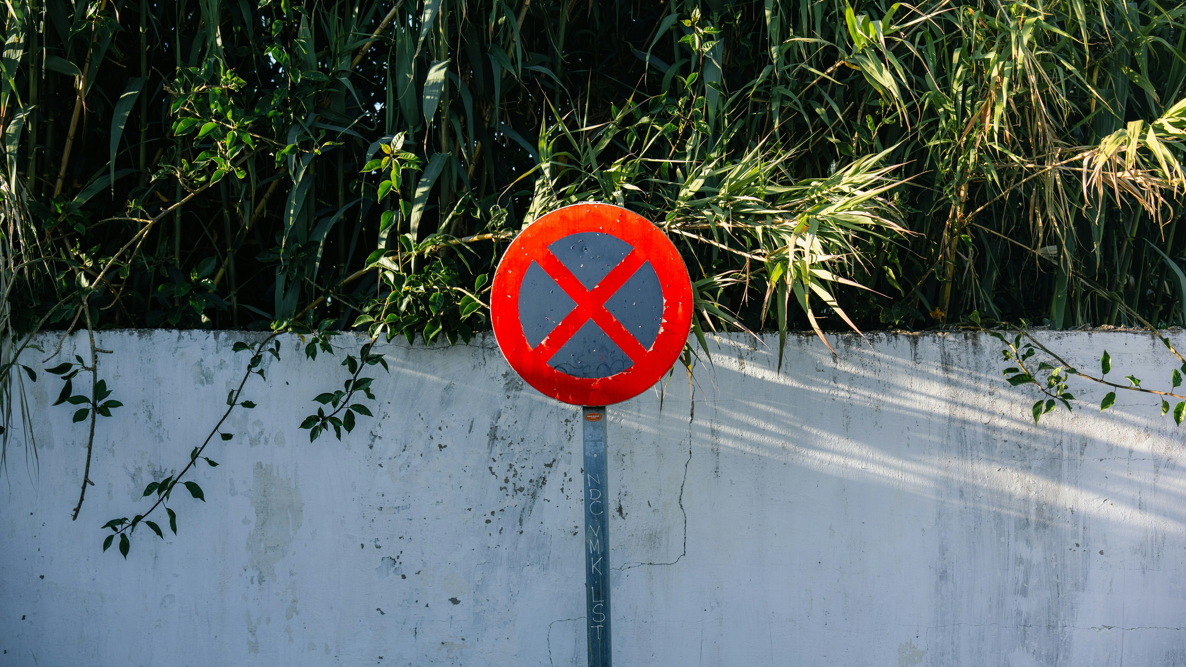 Red X Sign Against a Weathered Wall