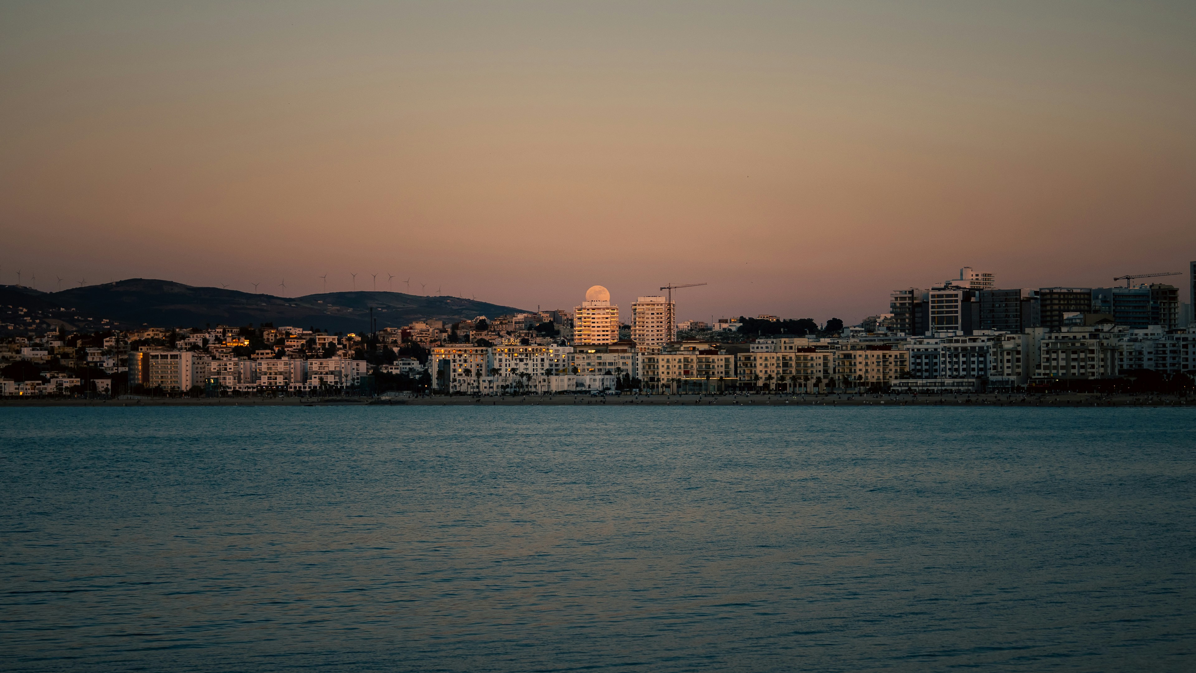 Dusk Over the Coastal City: Calm Sea, Quiet Skyline