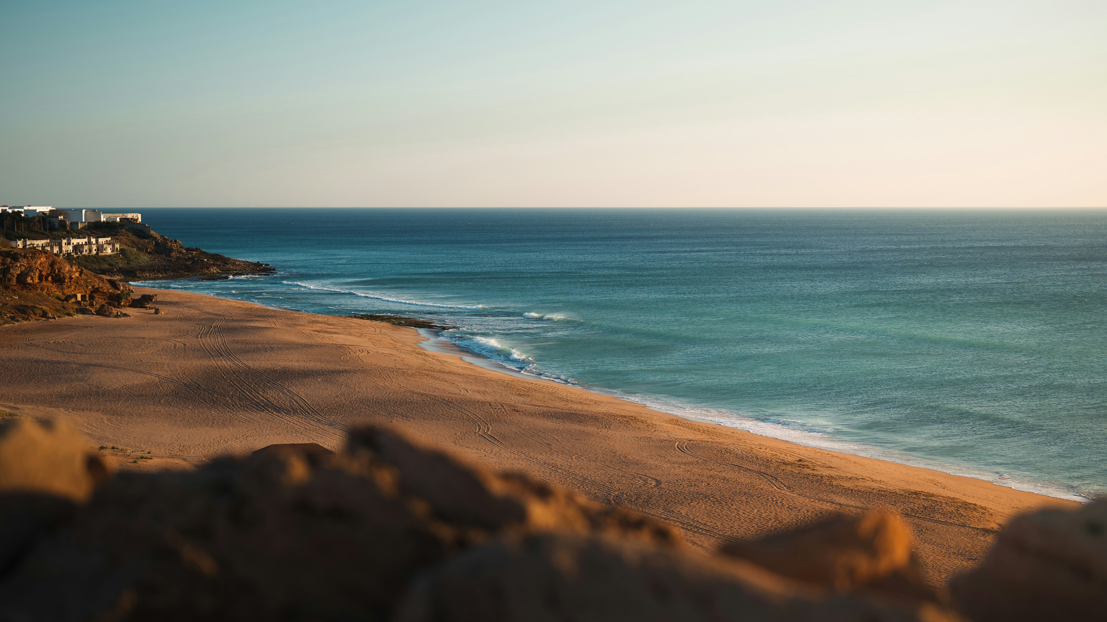 Coastal Cliffline at Dusk: Quiet Beach Meeting the Ocean
