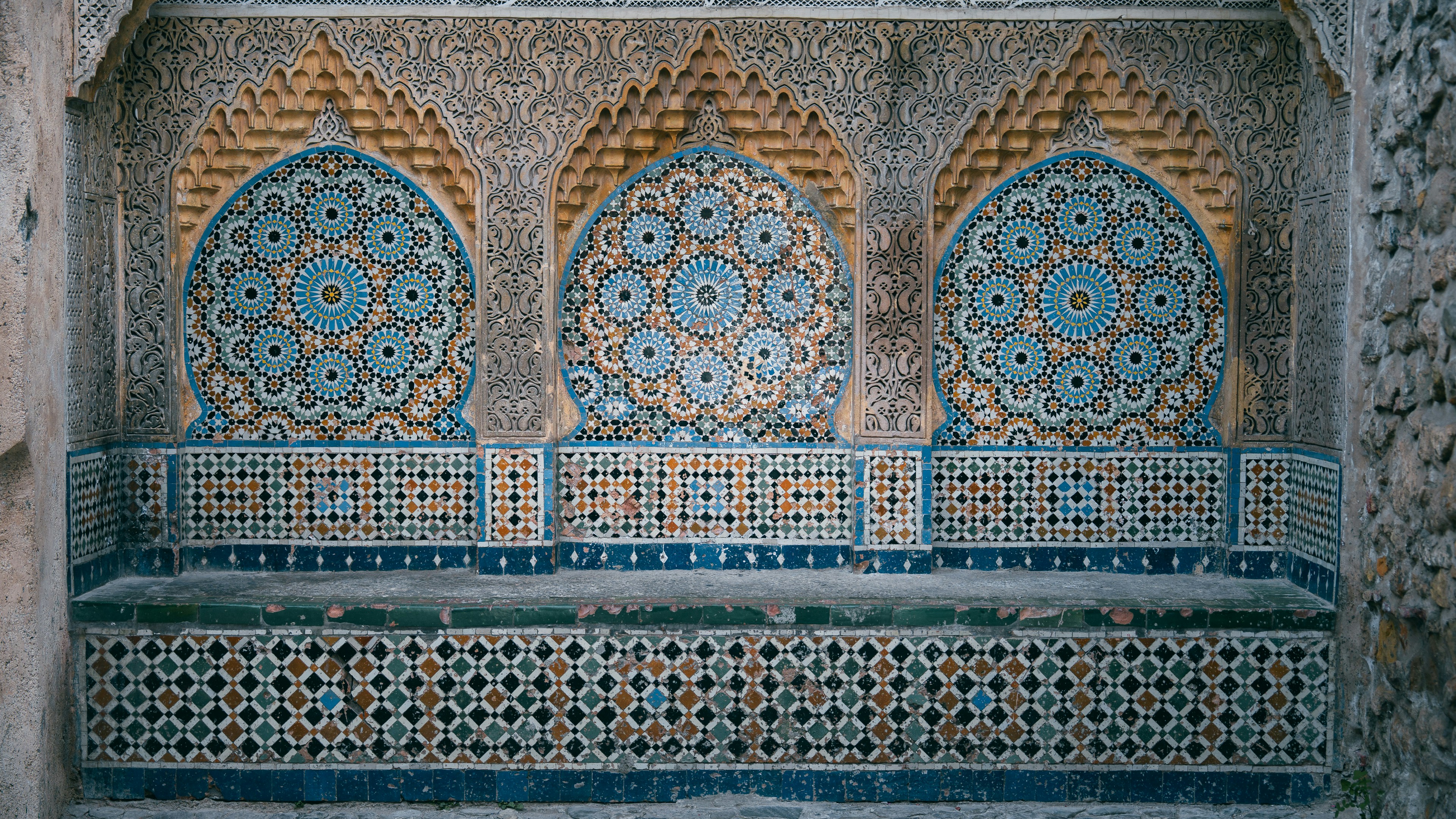 Mosaic Symmetry: Repeating Archways and Latticework in Blue Tile