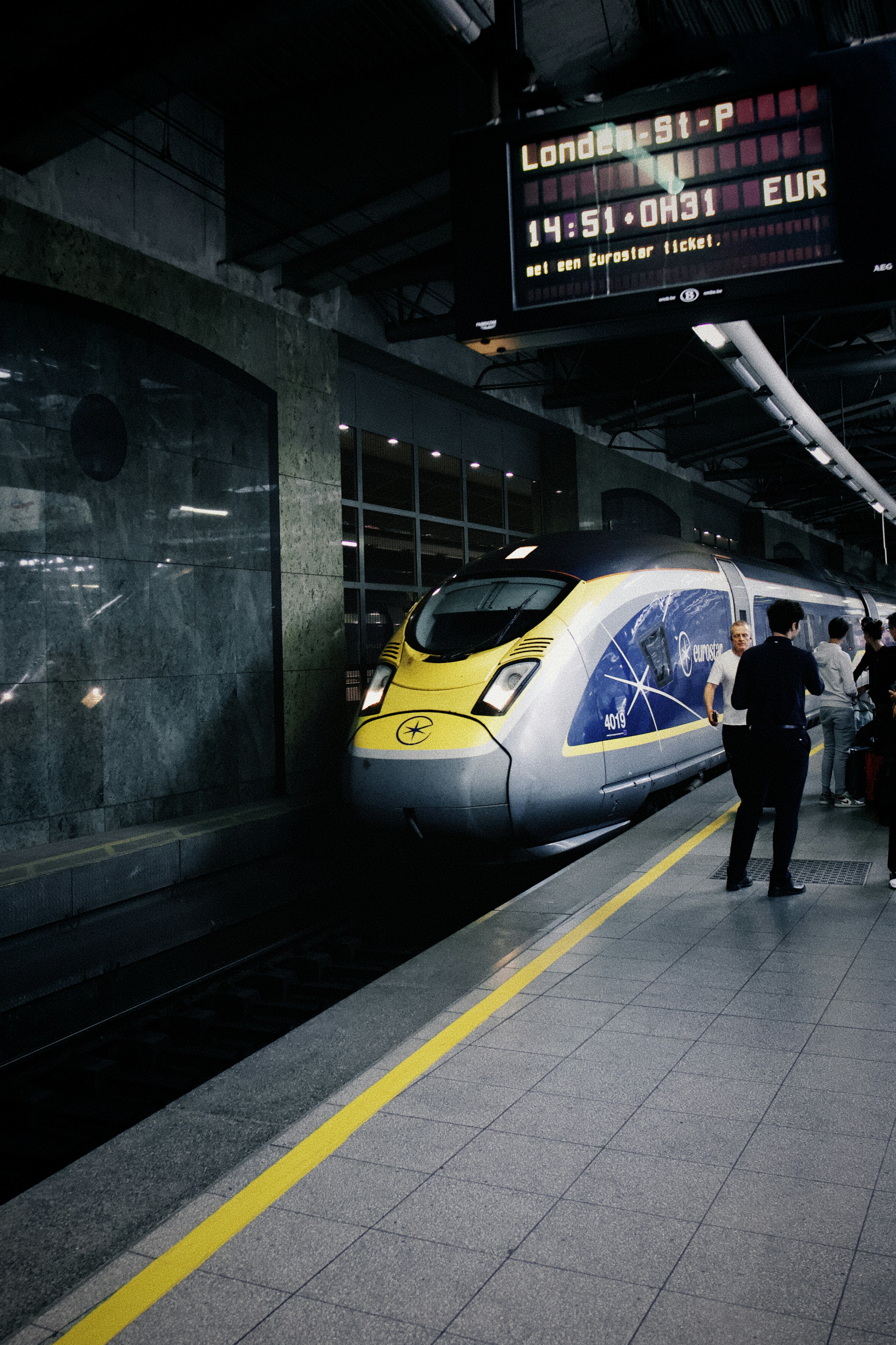 High-Speed Silence: An Alpine Blue Train at Platform Edge