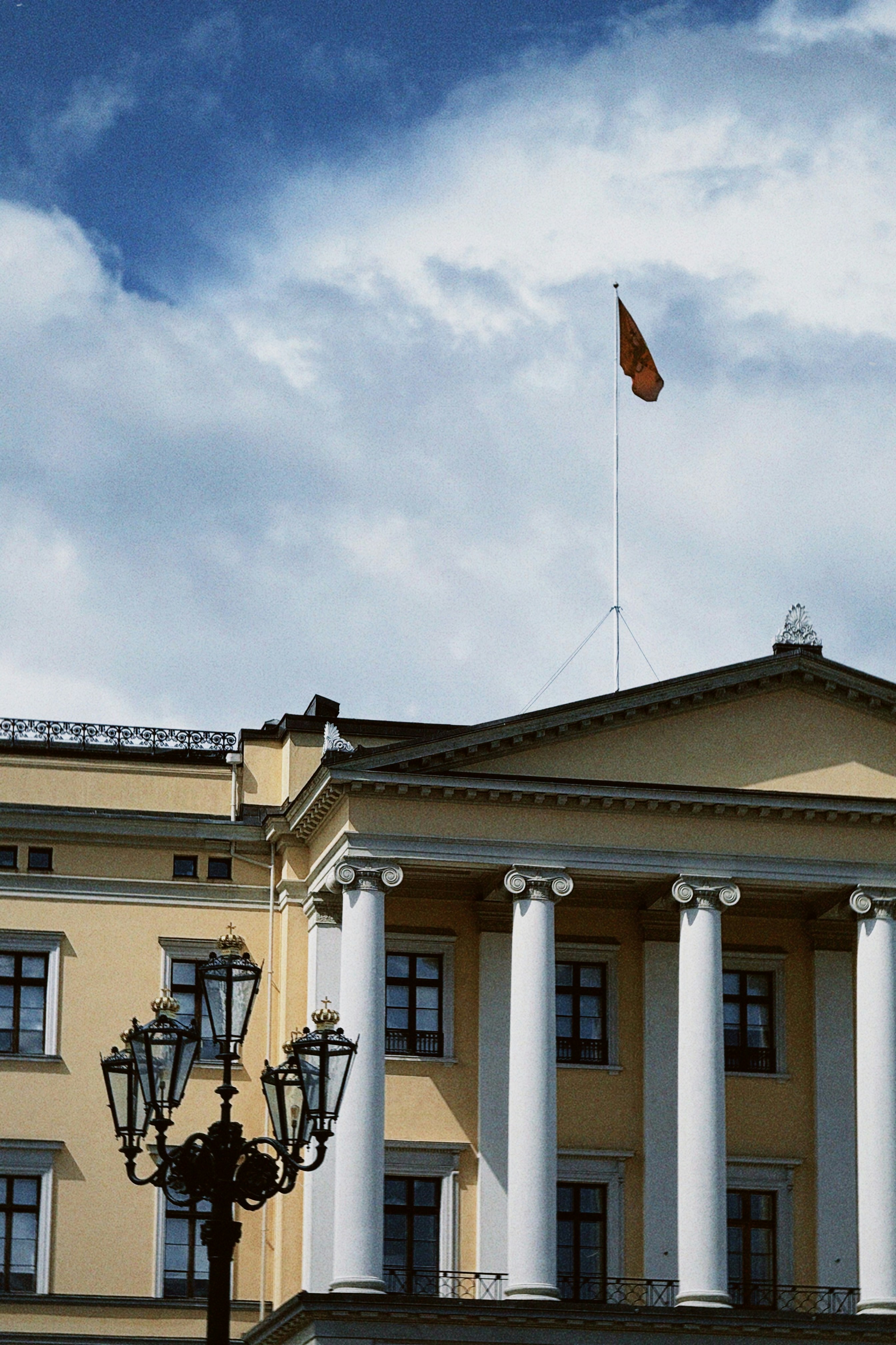 Neoclassical Facade Under a Sky of White Clouds
