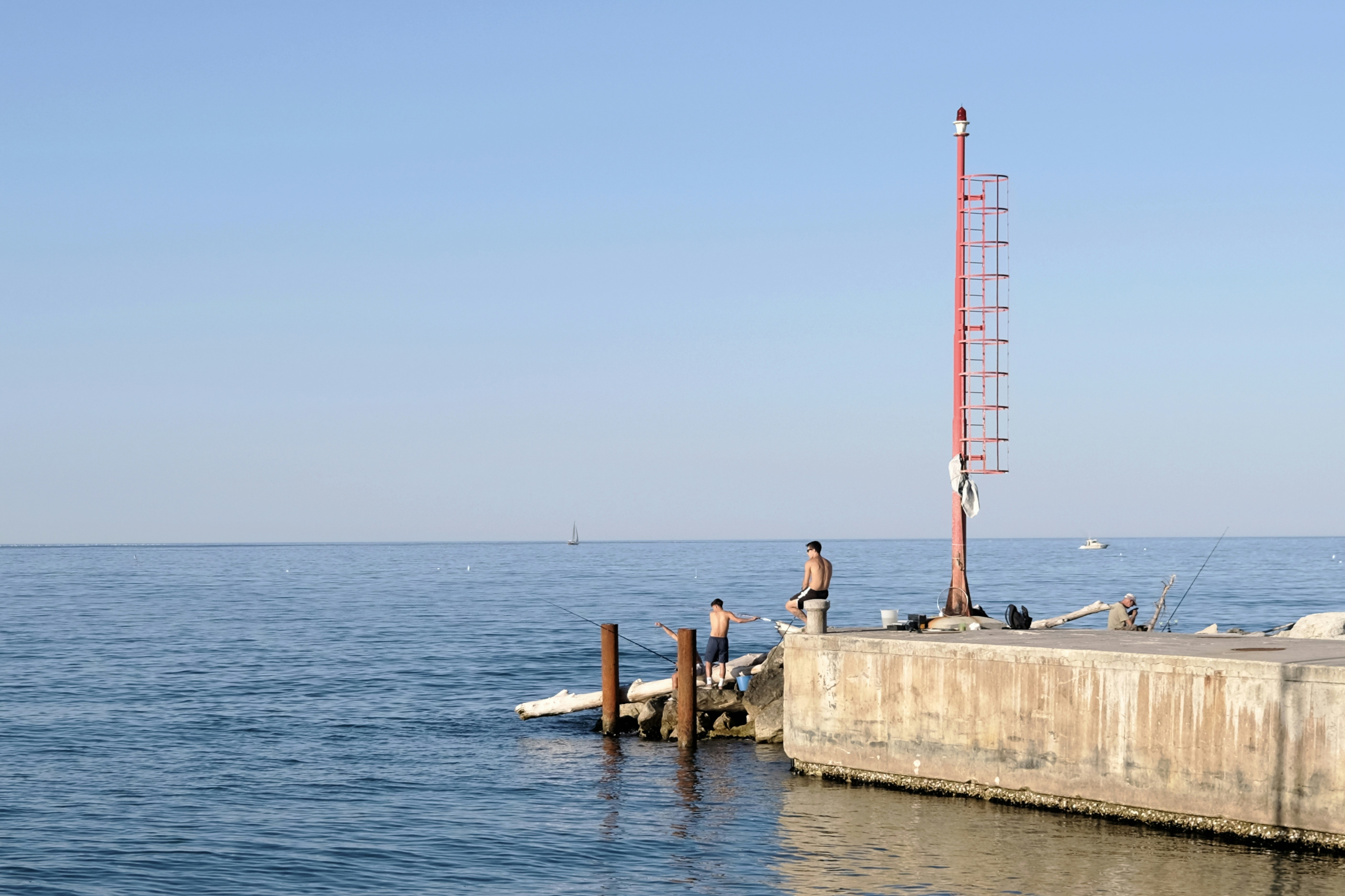 Harbor Pier at Dusk: Quiet Figures by the Sea