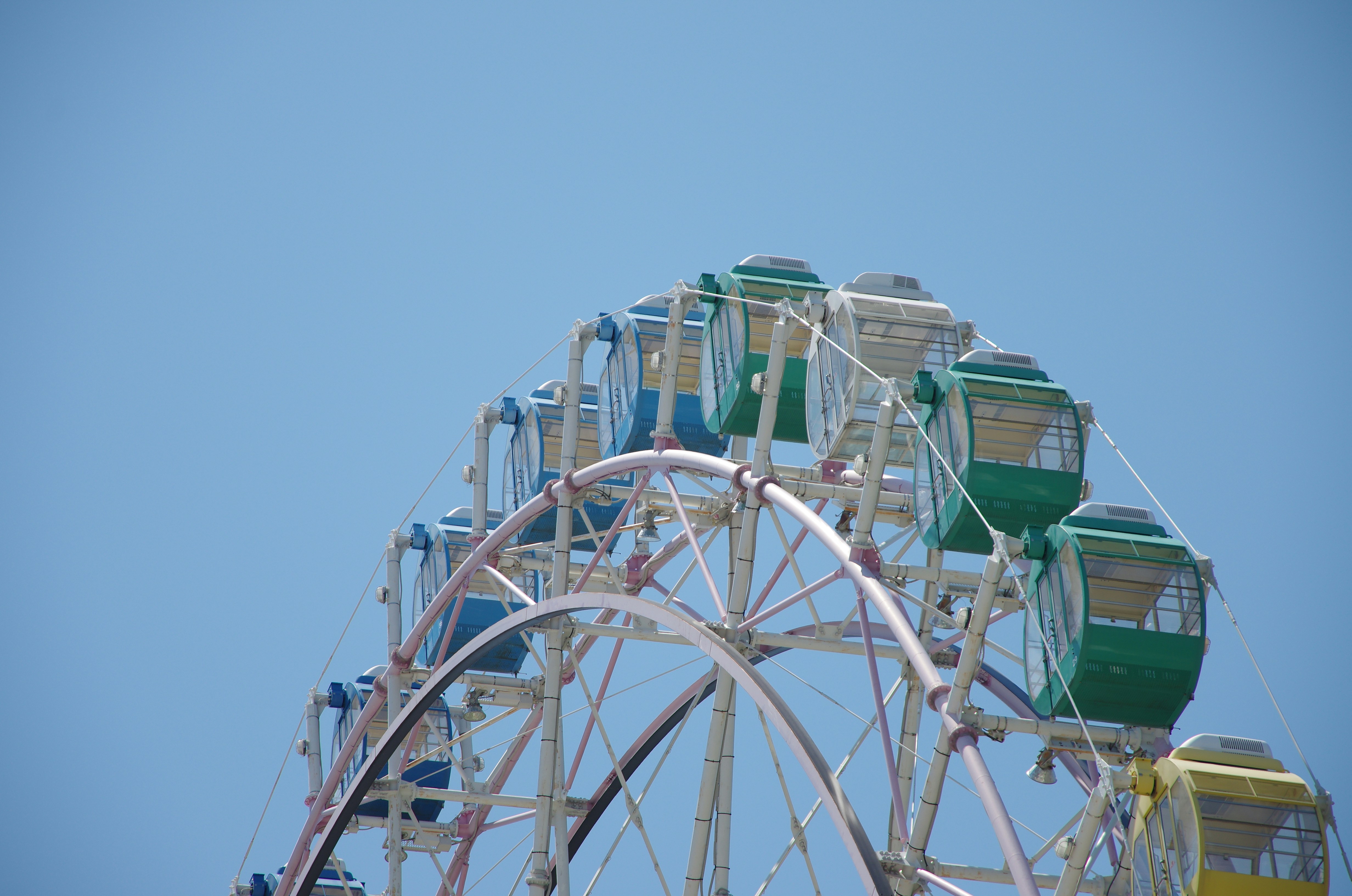 Pastel Gravity: A Tilted Ferris Wheel Reaches for the Sky