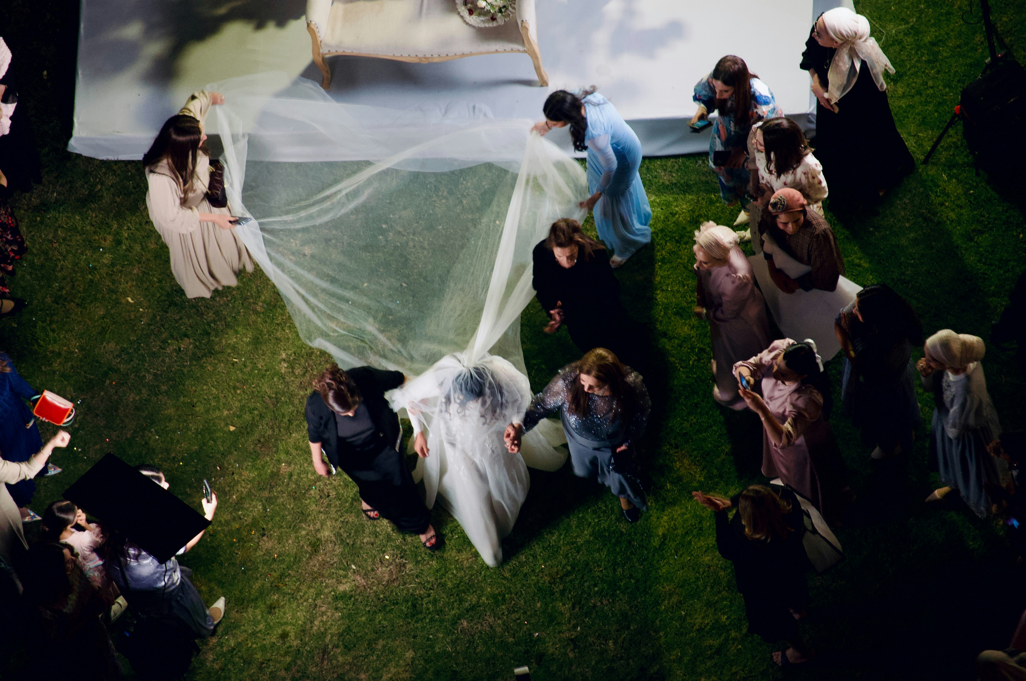 Aerial Moment: Bride’s Veil Flows Over a Gathered Unity