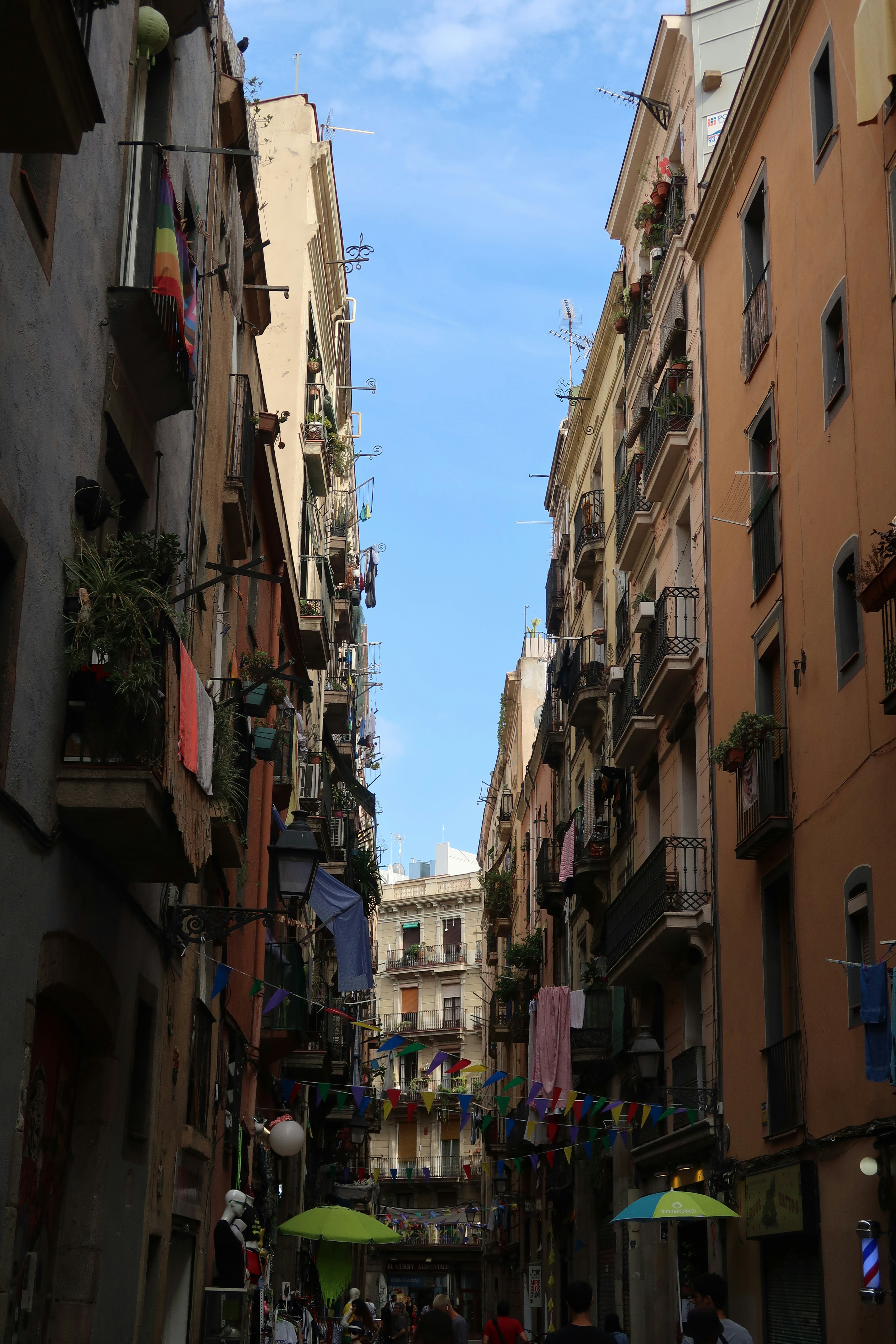 Sunlit Alleyway Between Tall Buildings