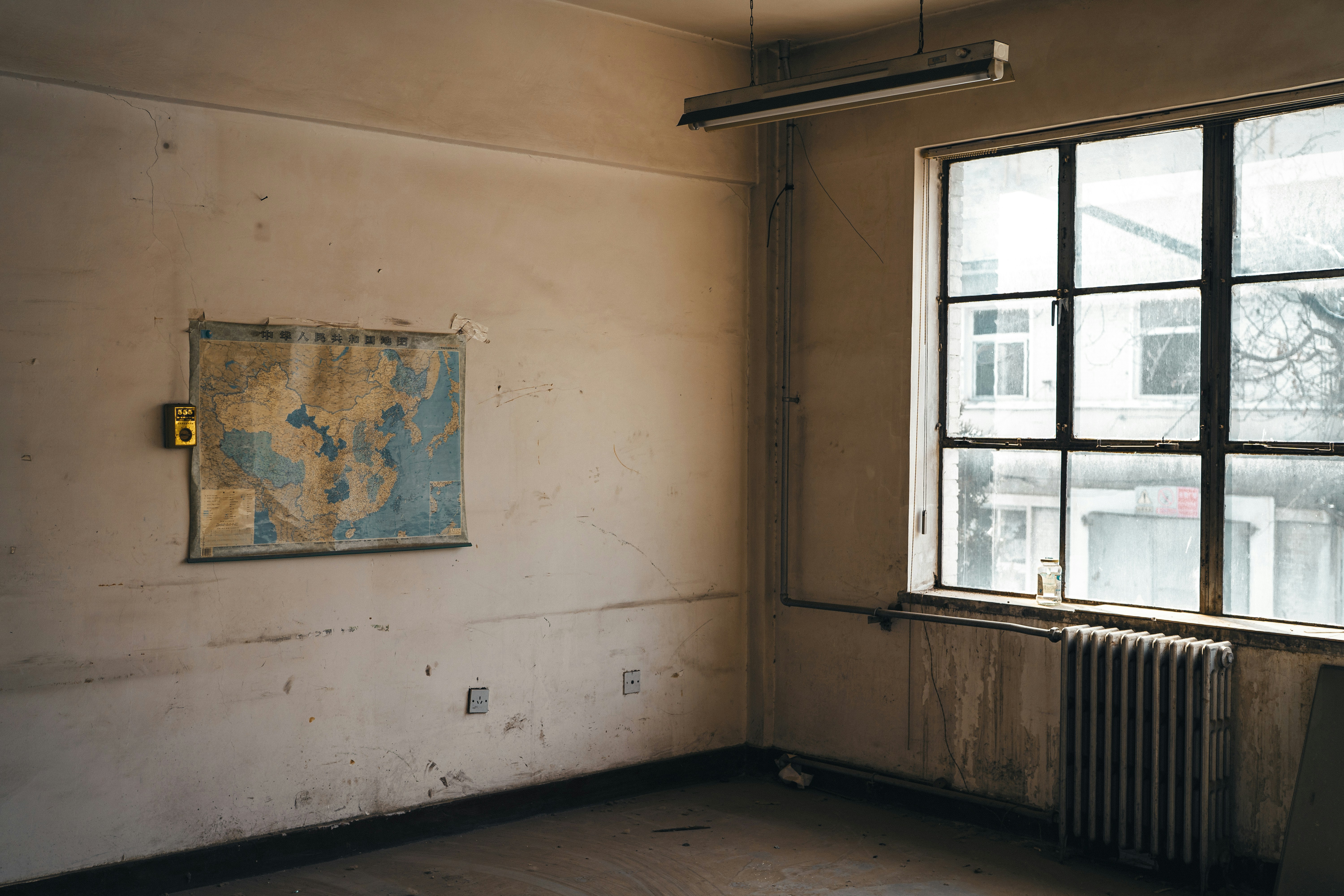 Abandoned Studio: Windows, Warped Light, and a Map on the Wall