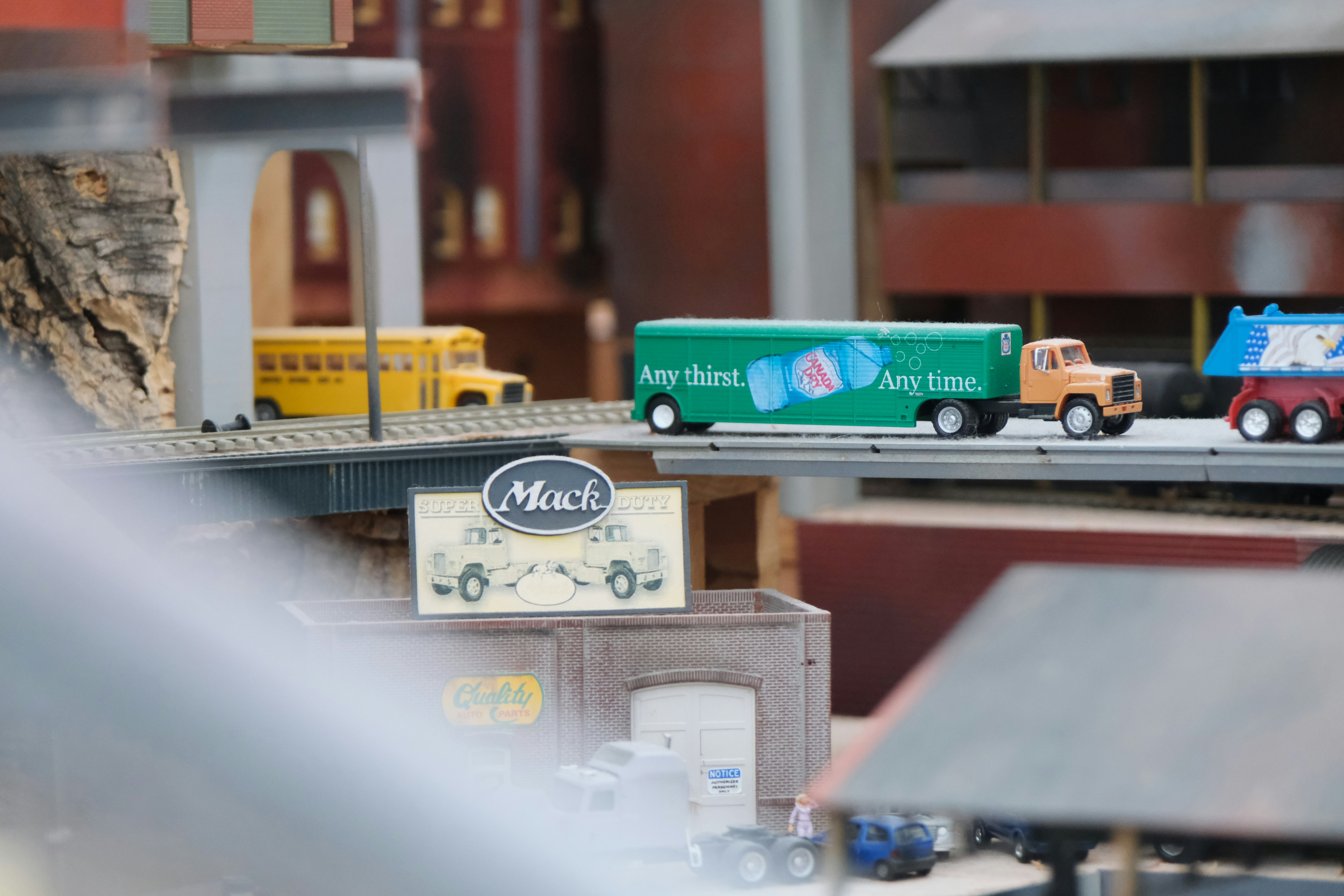 Miniature Freight Corridor: Green Truck Rides the Upper Rails