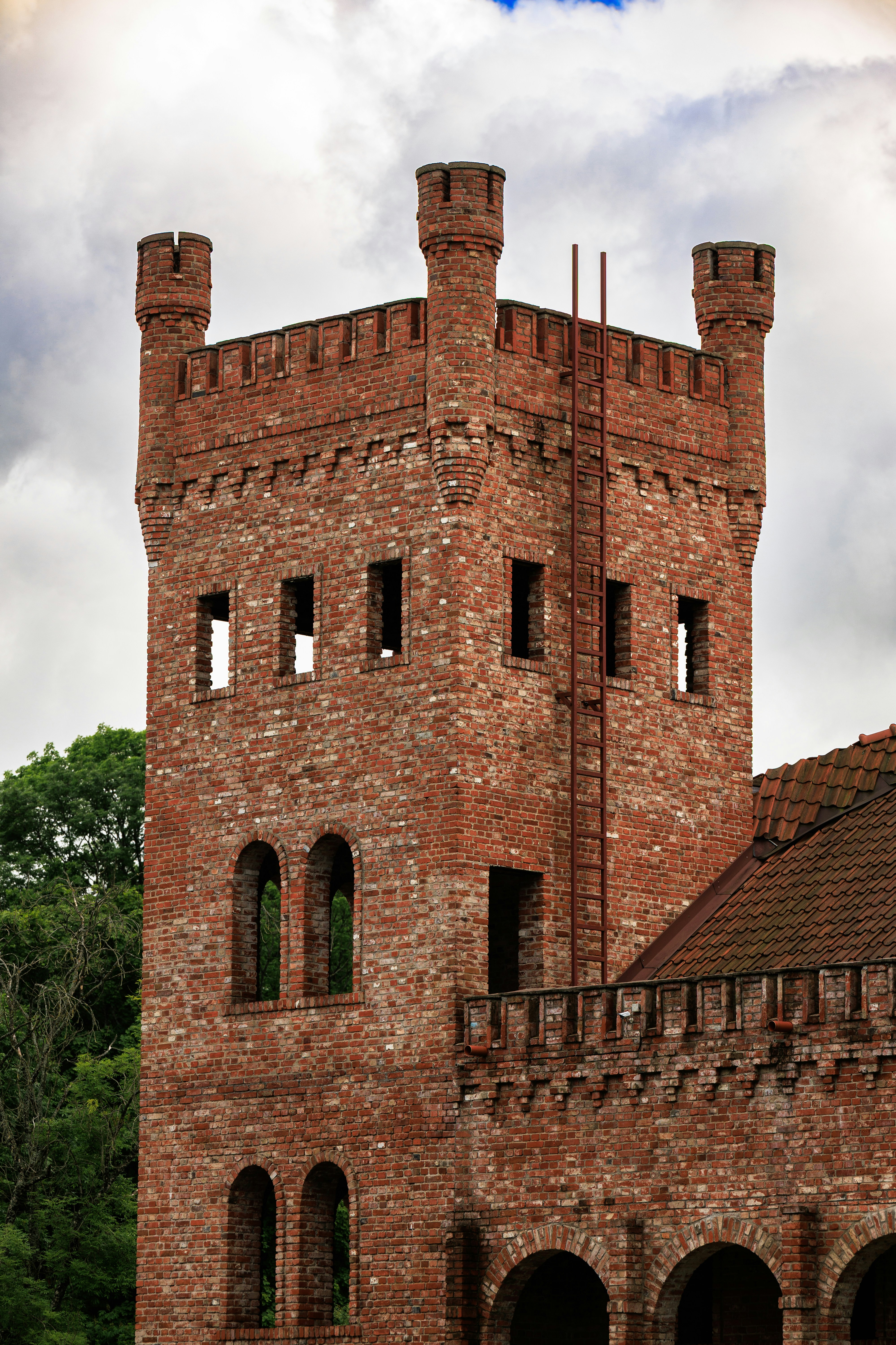 Brick Turreted Keep Reaching Toward a Cloudy Sky