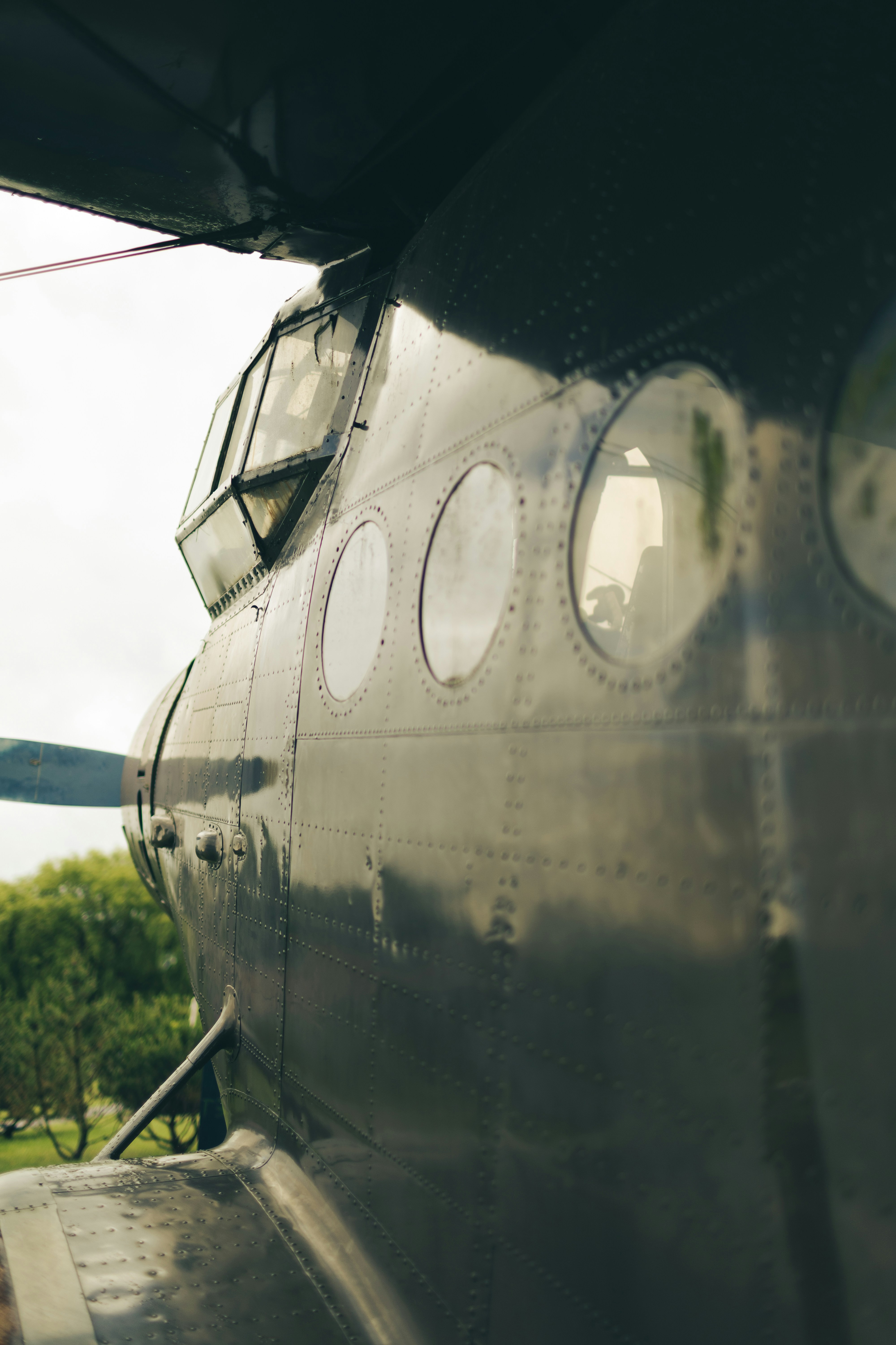 Vintage airplane fuselage with round windows and cockpit.