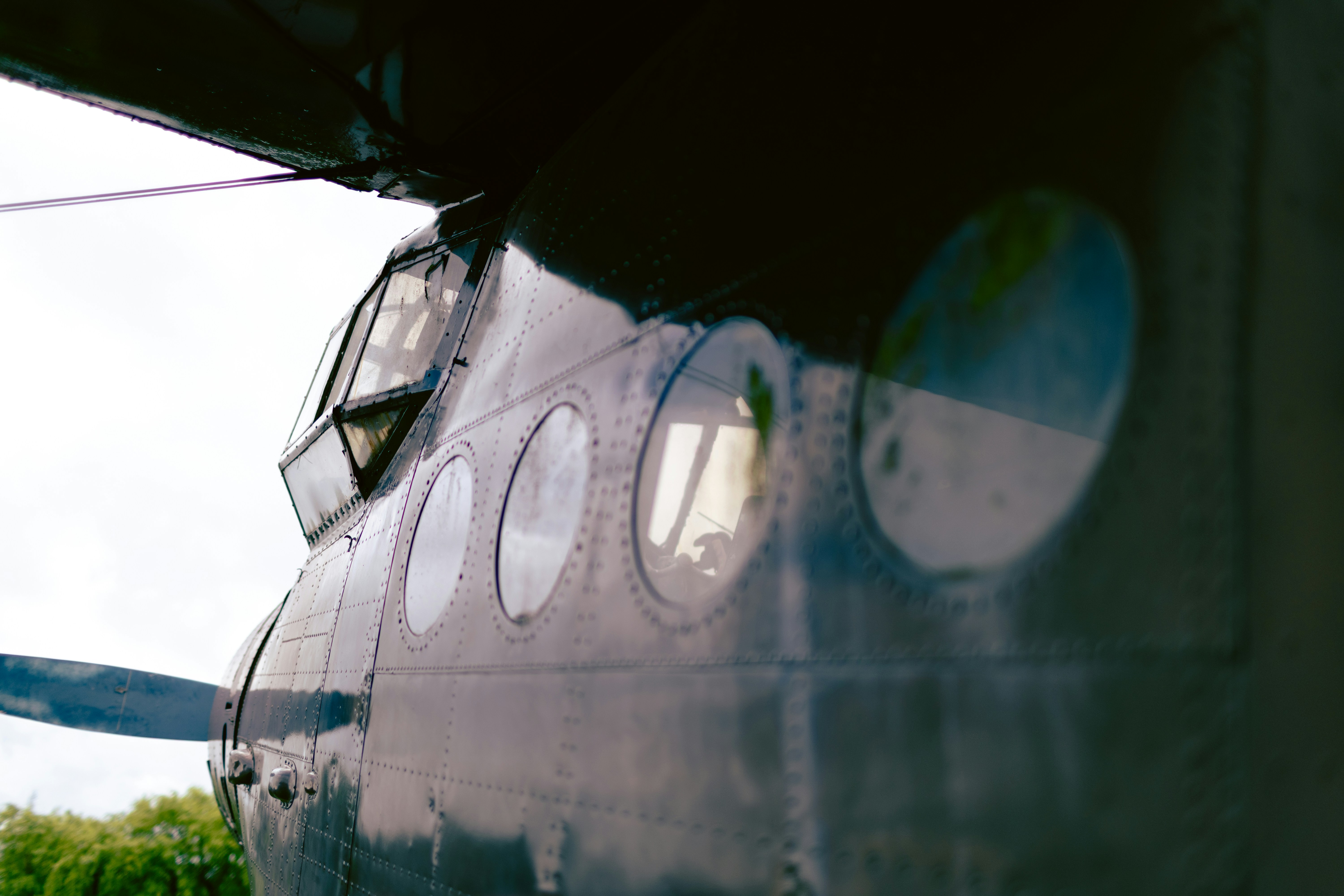 Vintage airplane fuselage with round windows and cockpit.