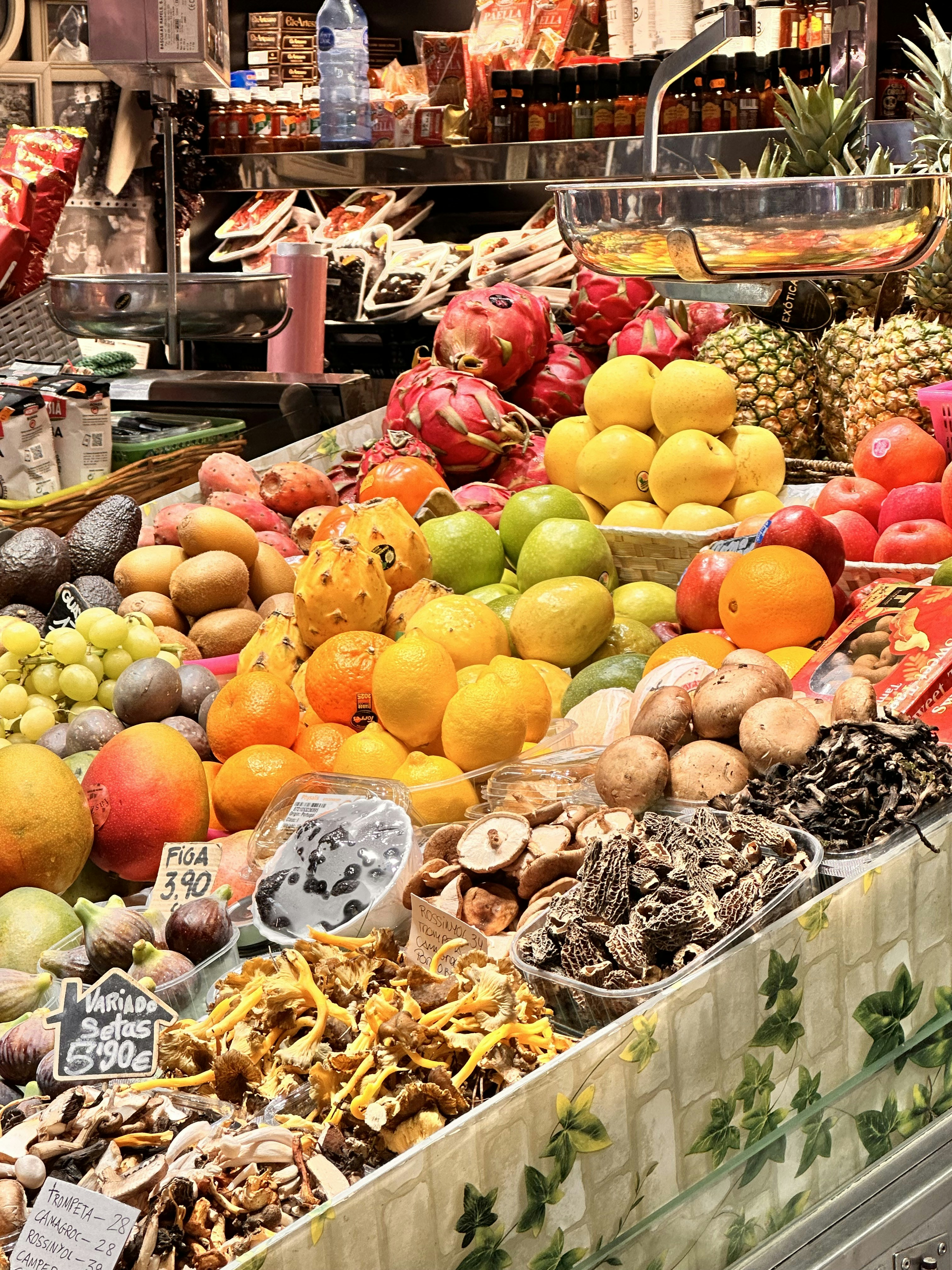 Towering Citrus Crown Over a Bustling Market Fruit Stand