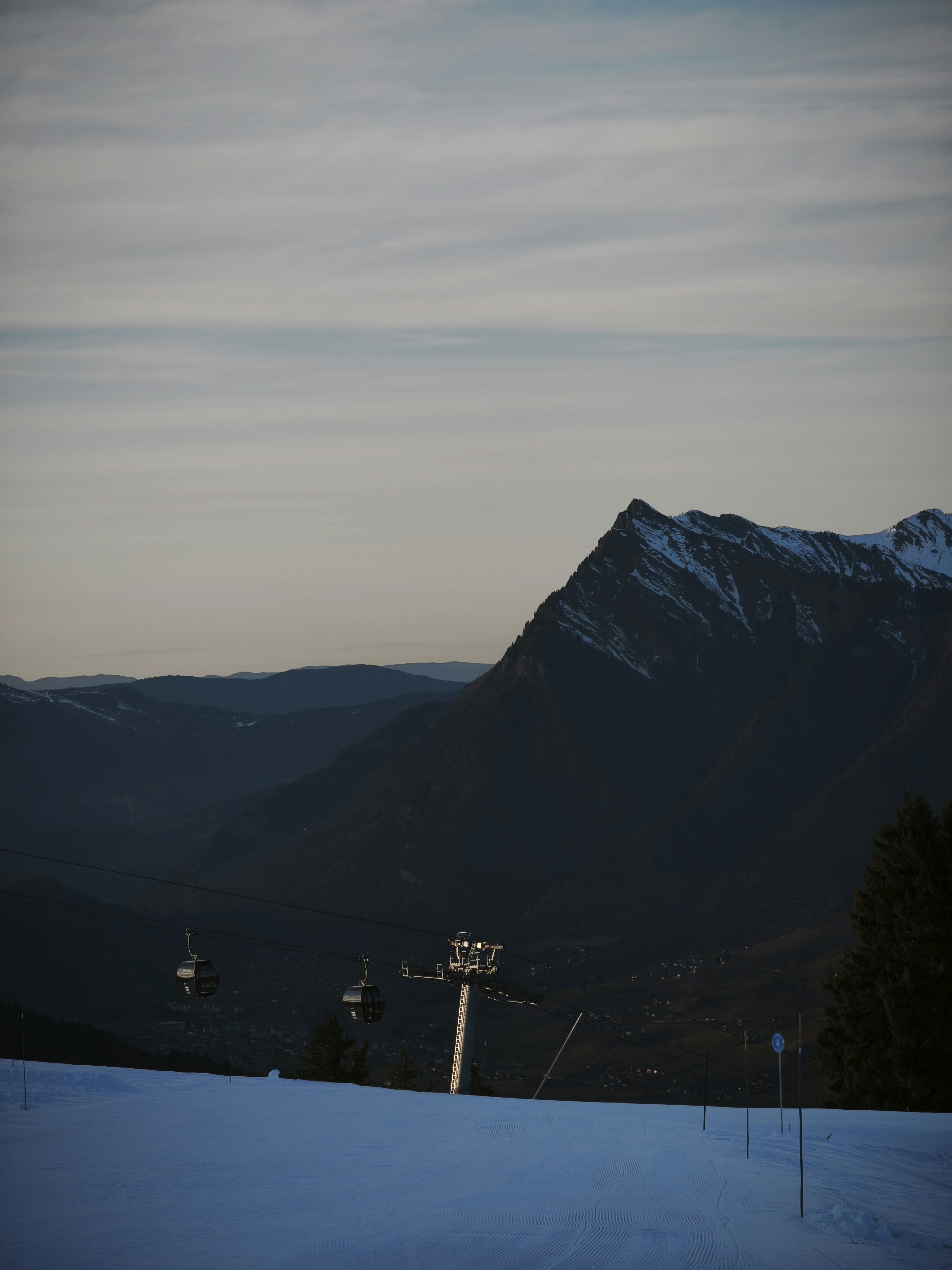 Snow‑capped Summit Meeting the Sky Over a Quiet Ski Slopes