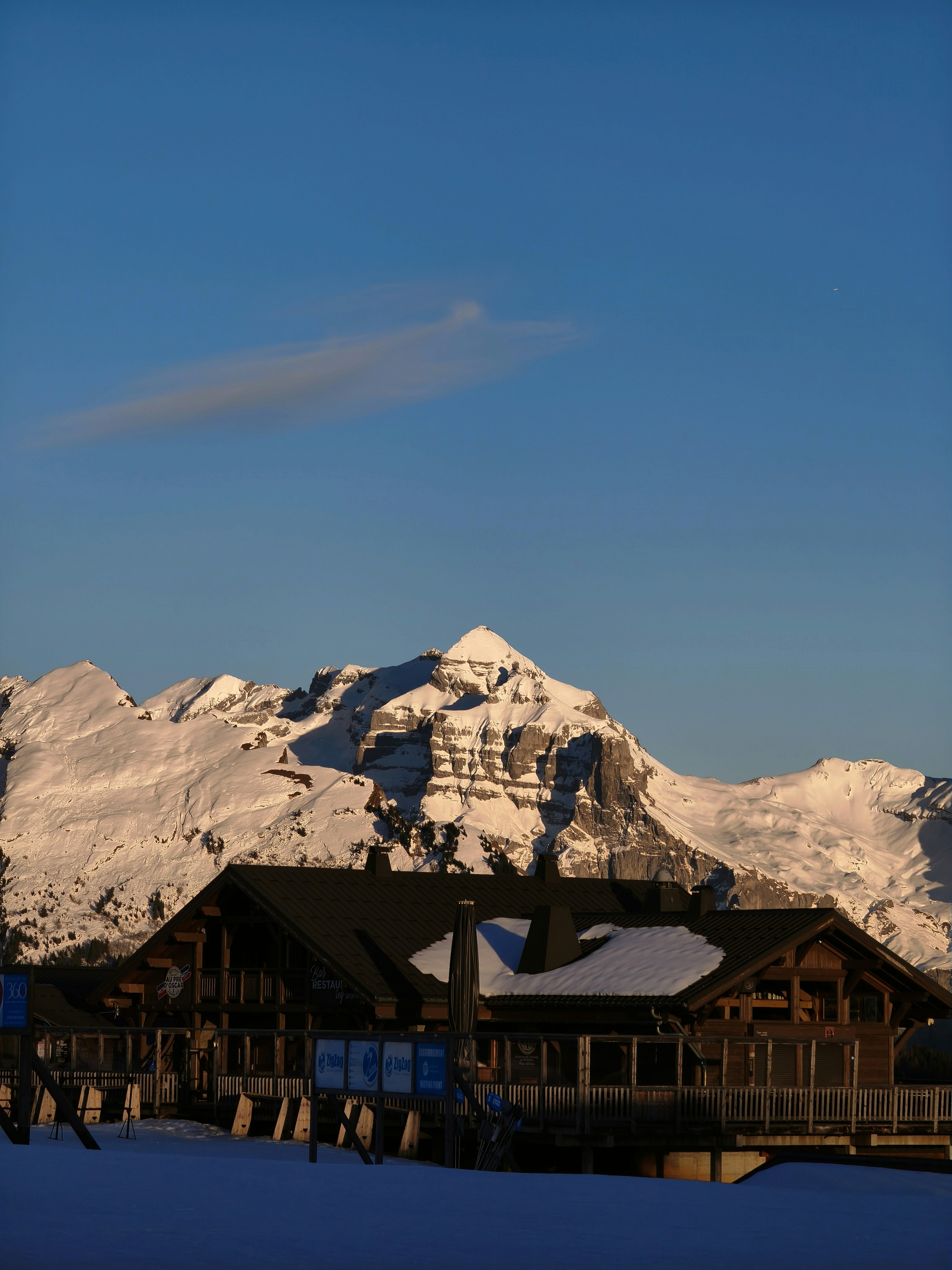 Snowbound Peaks Behind a Rustic Alpine Lodge