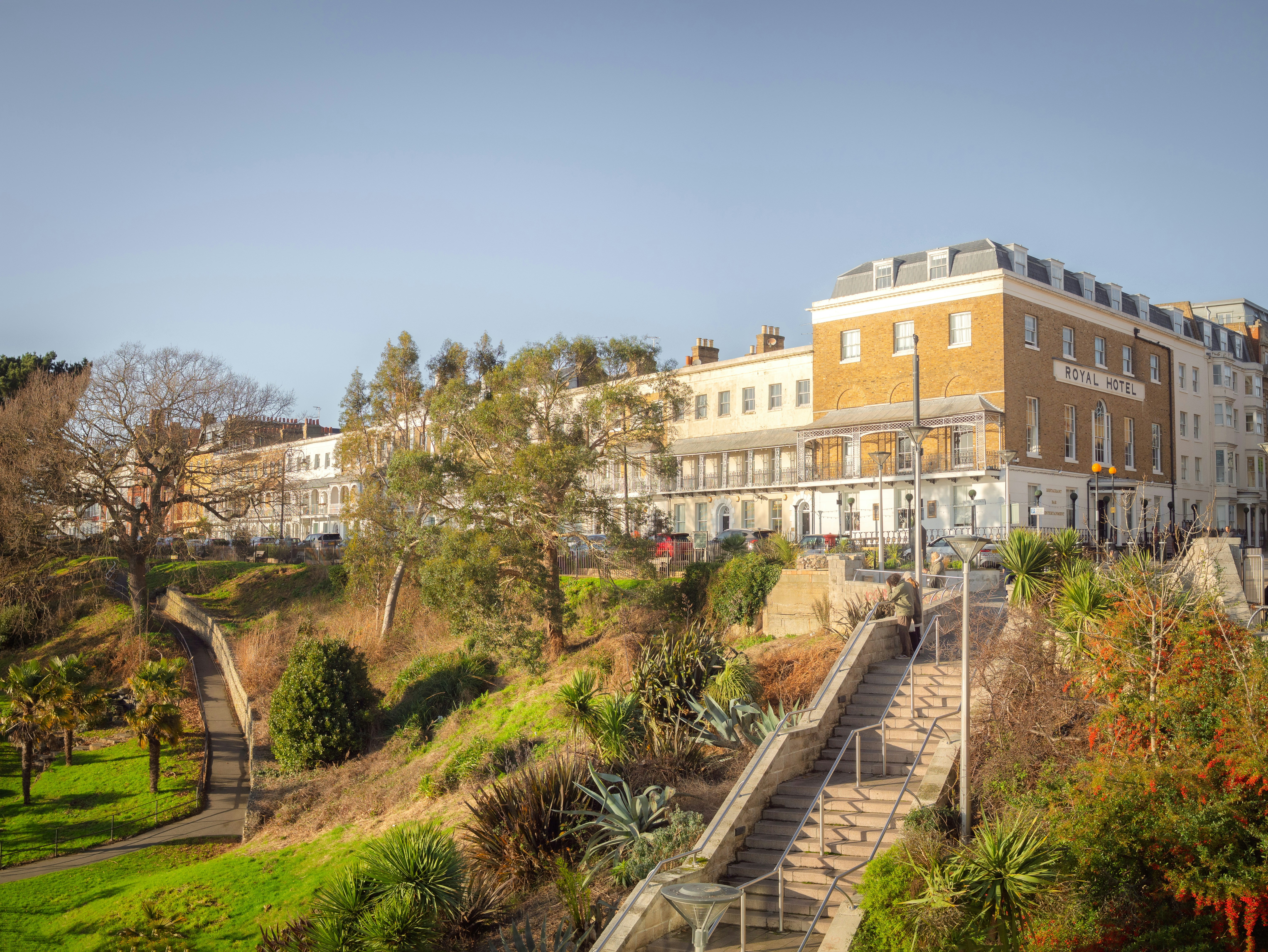 Terraced hillside with urban terrace houses under a clear blue sky
