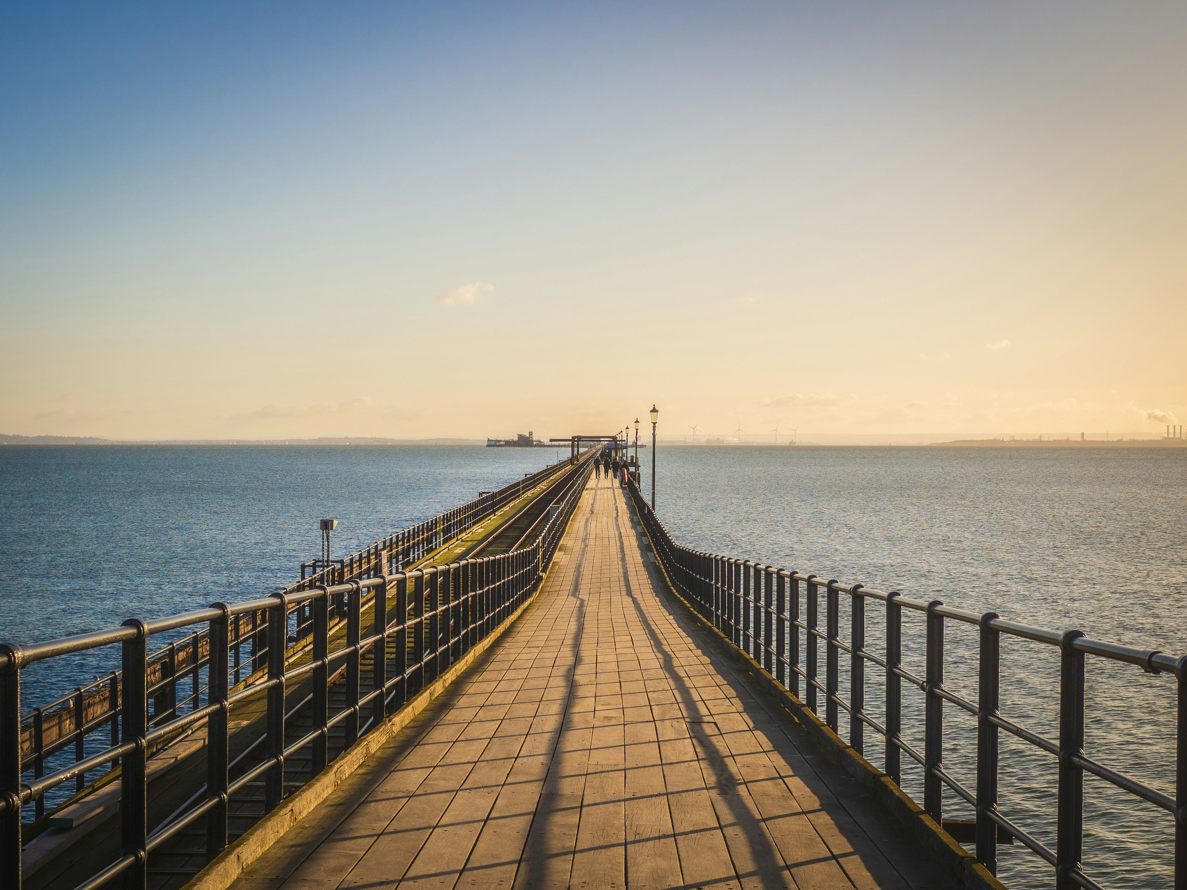 Symmetrical perspective view looking down the long walkway of Southend Pier.