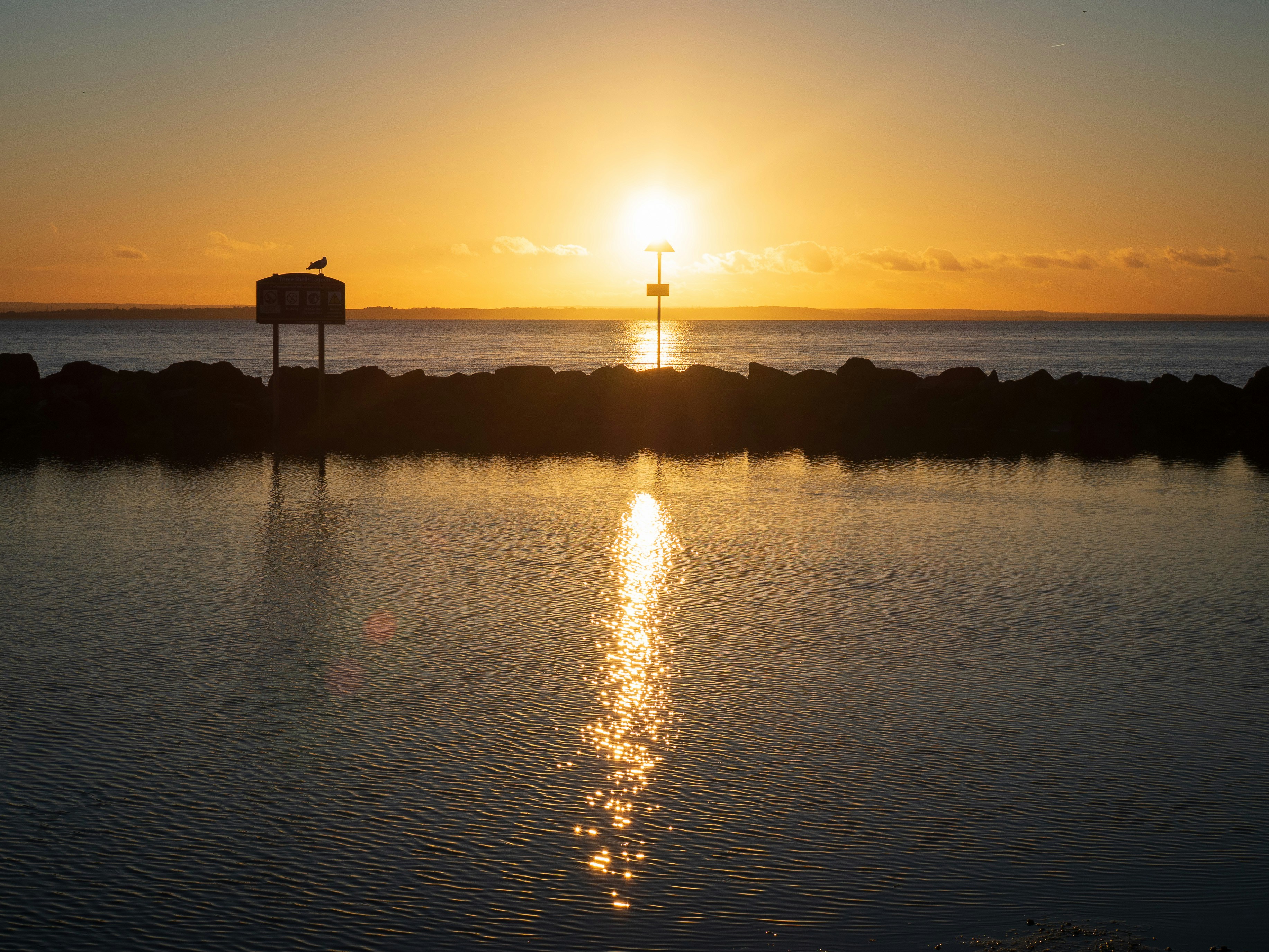 Sunlit Prominence: The Quiet Pier Beneath the Dusk