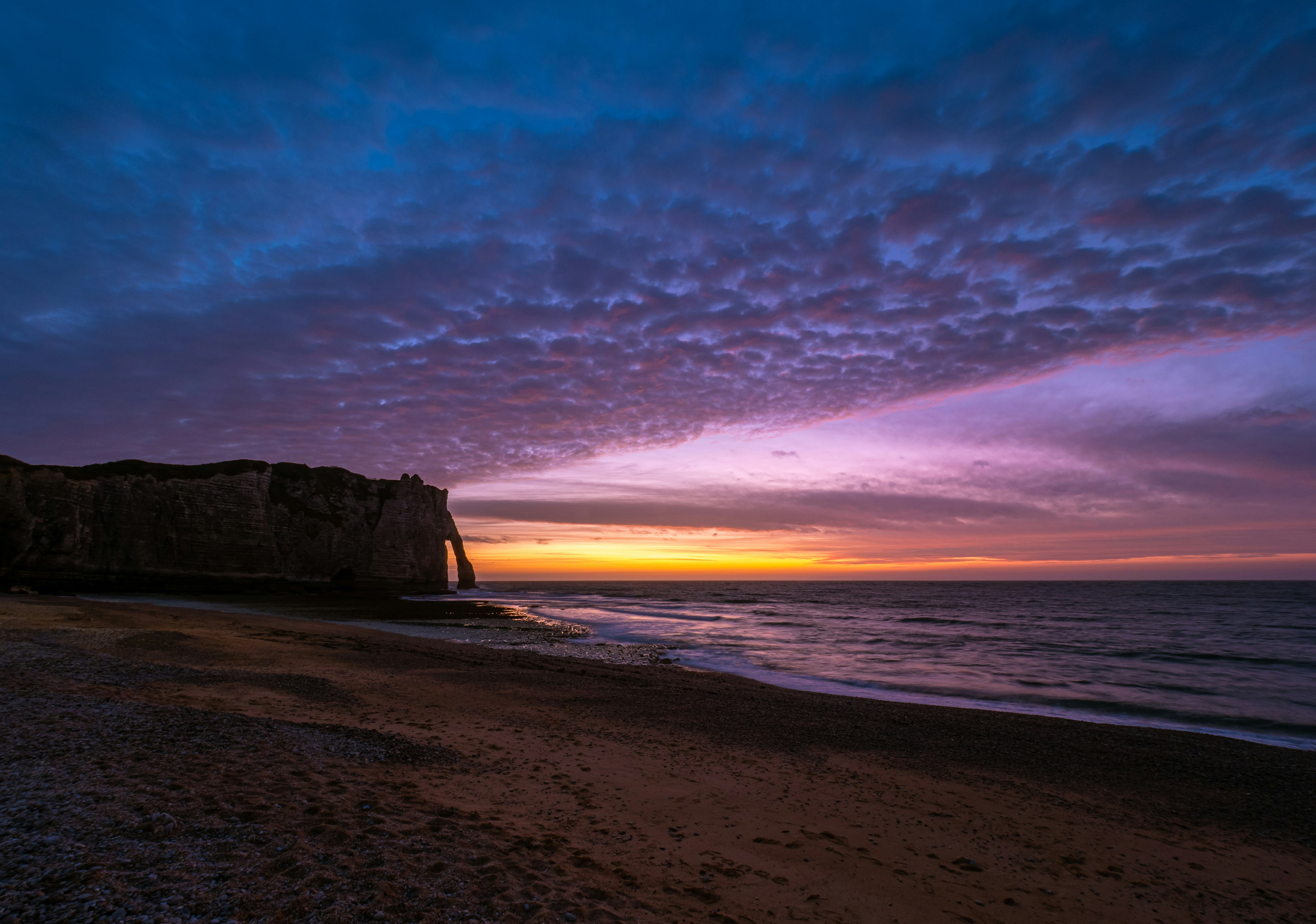 Twilight Cliff silhouettes over a tranquil sea