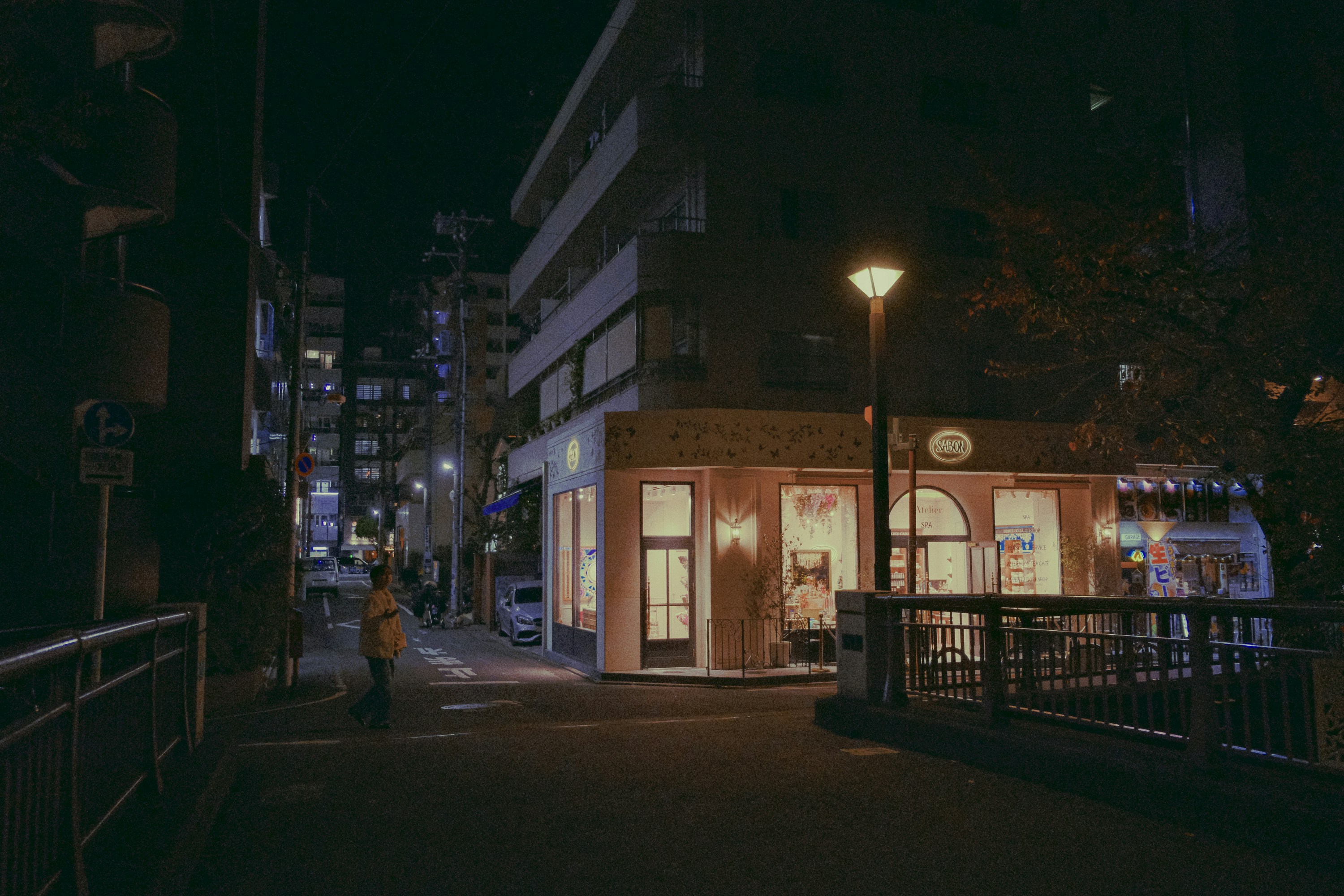 Neon Corner: Quiet Street Beneath a Nightwell