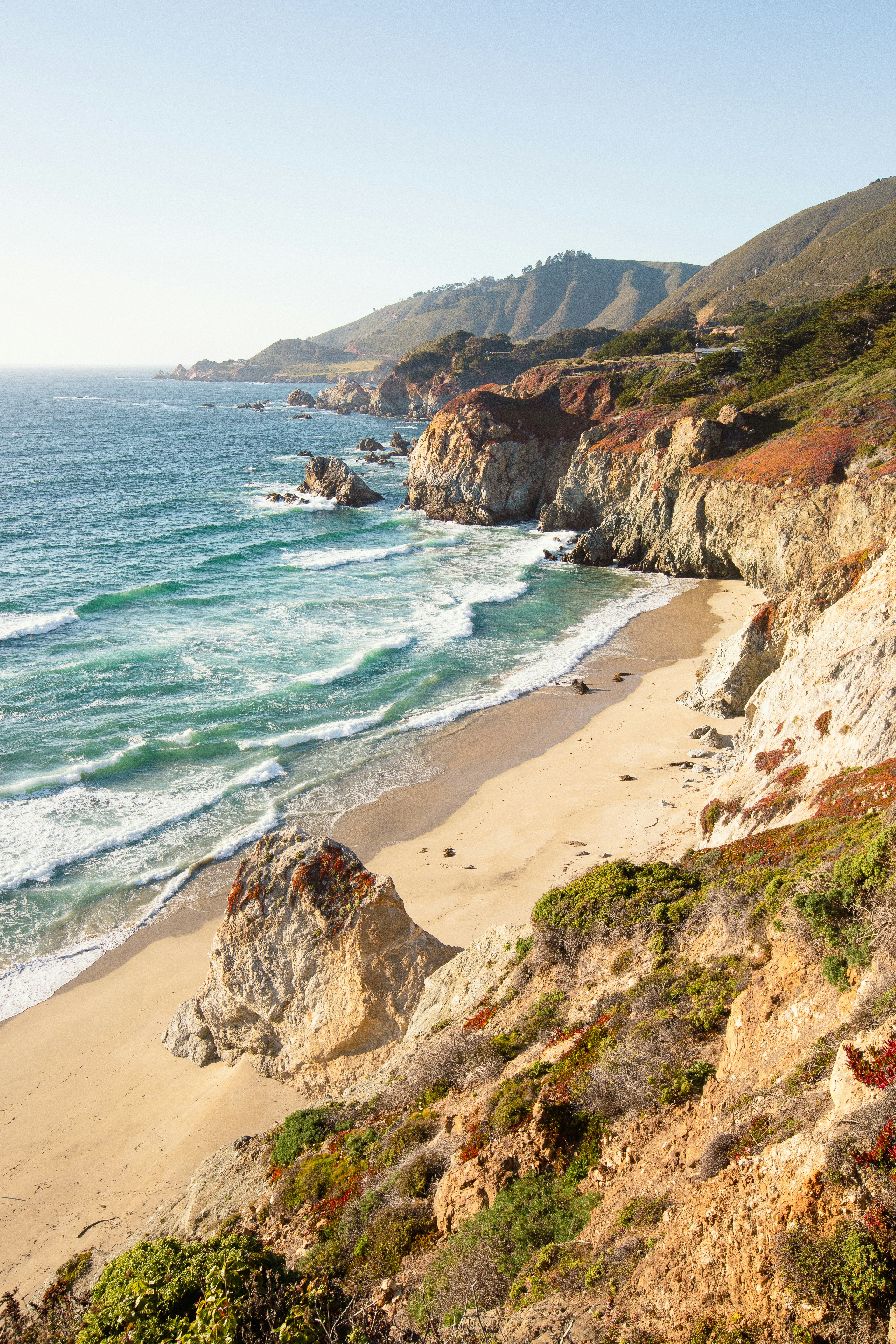Cliffside Coastal Walk: Sunlit Waves and Weathered Rocks