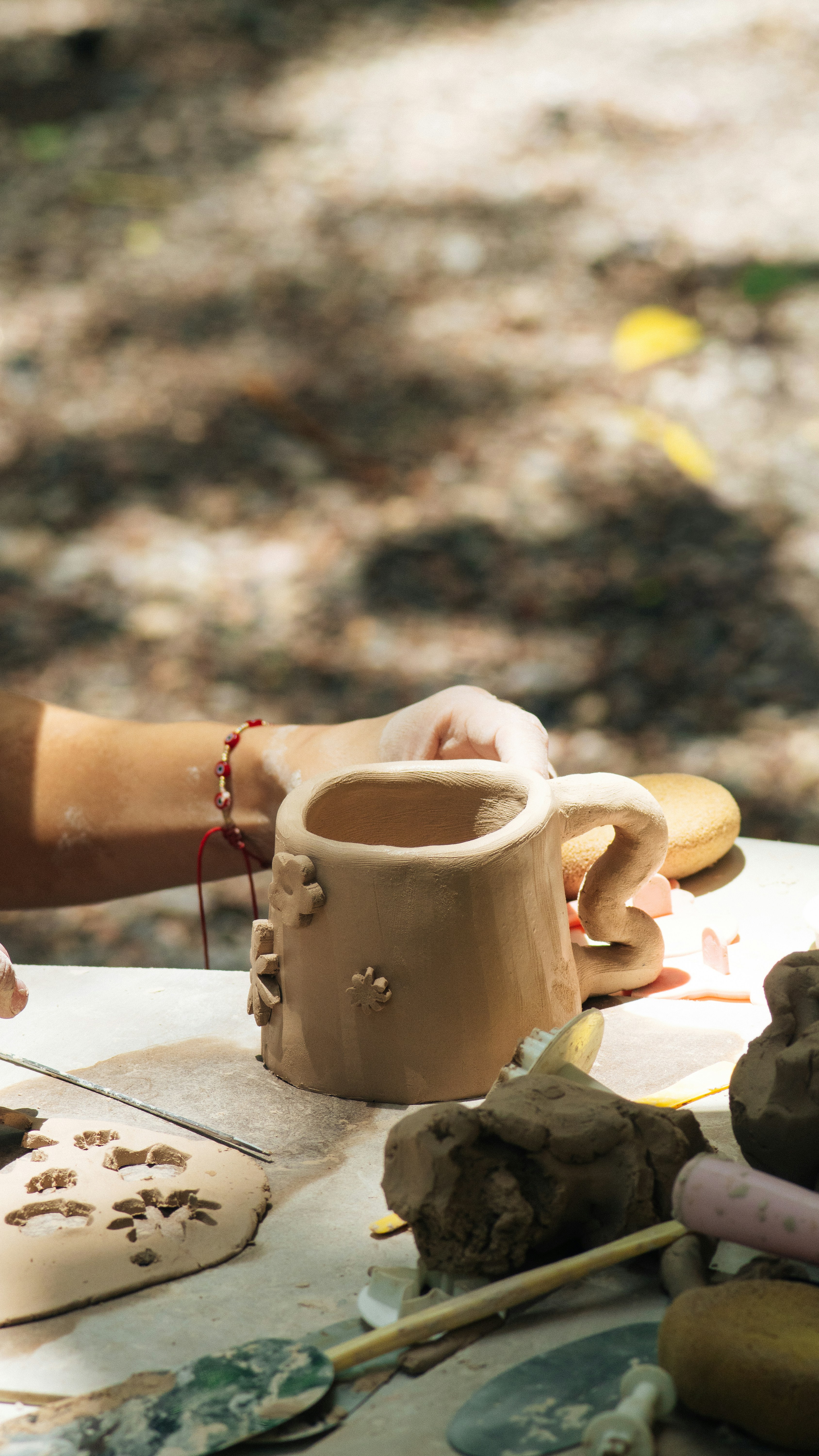 Hands at the Pottery Wheel: Crafting Clay into Mug Shapes
