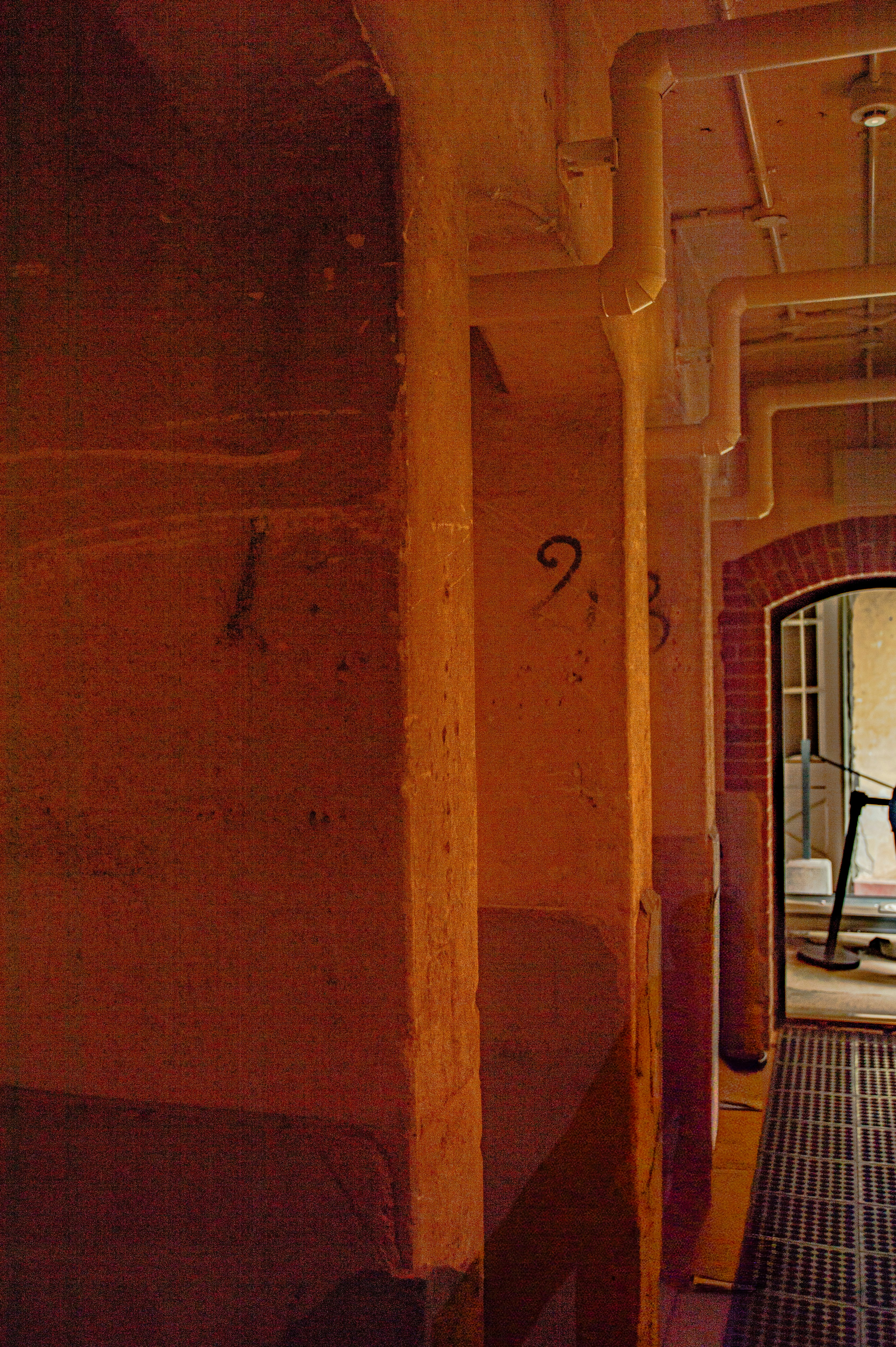 Tunnel of Pipes and Archway: Silent Corridor in Warm Light
