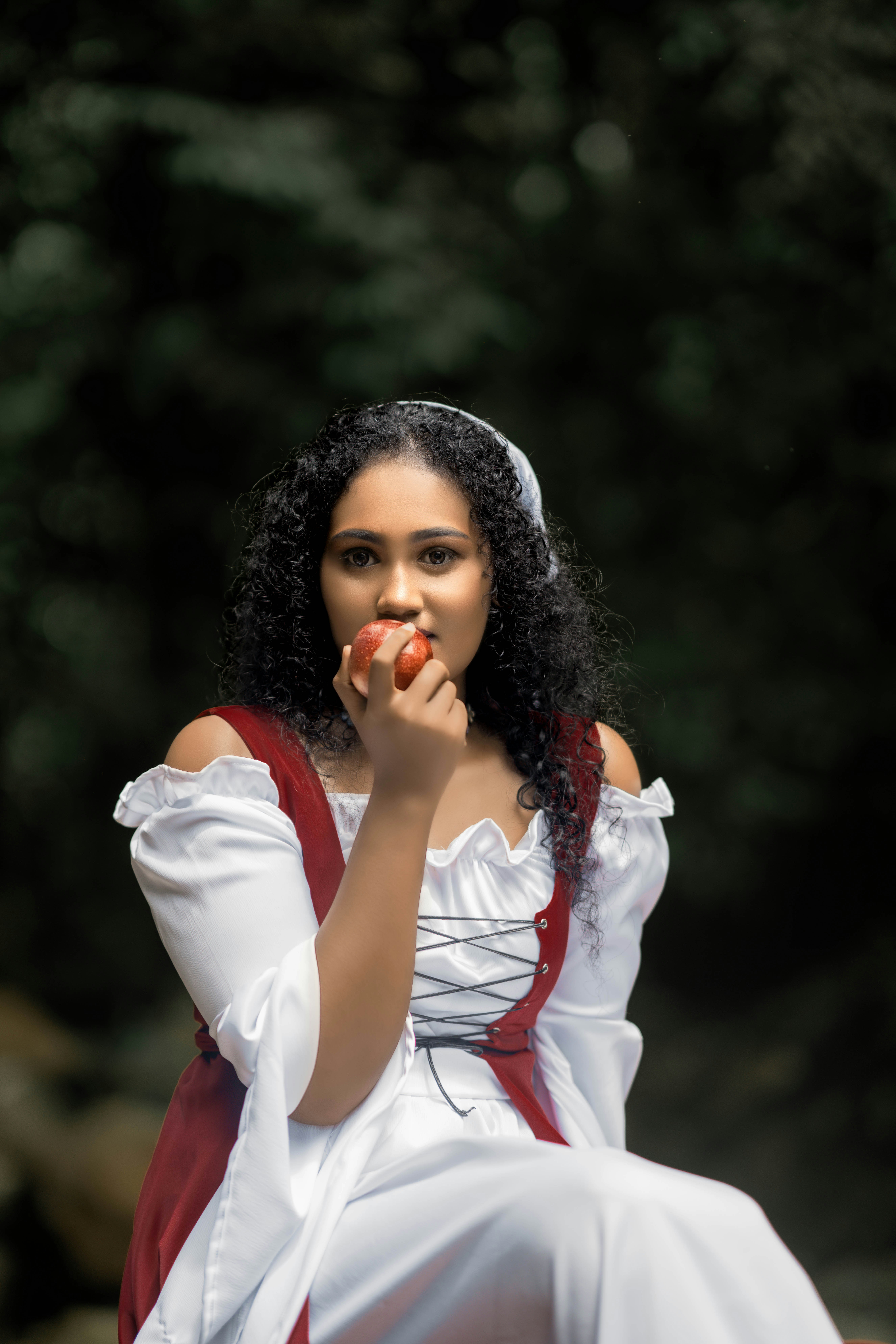 Red-robed Grace: A portrait of quiet strength in a forest setting