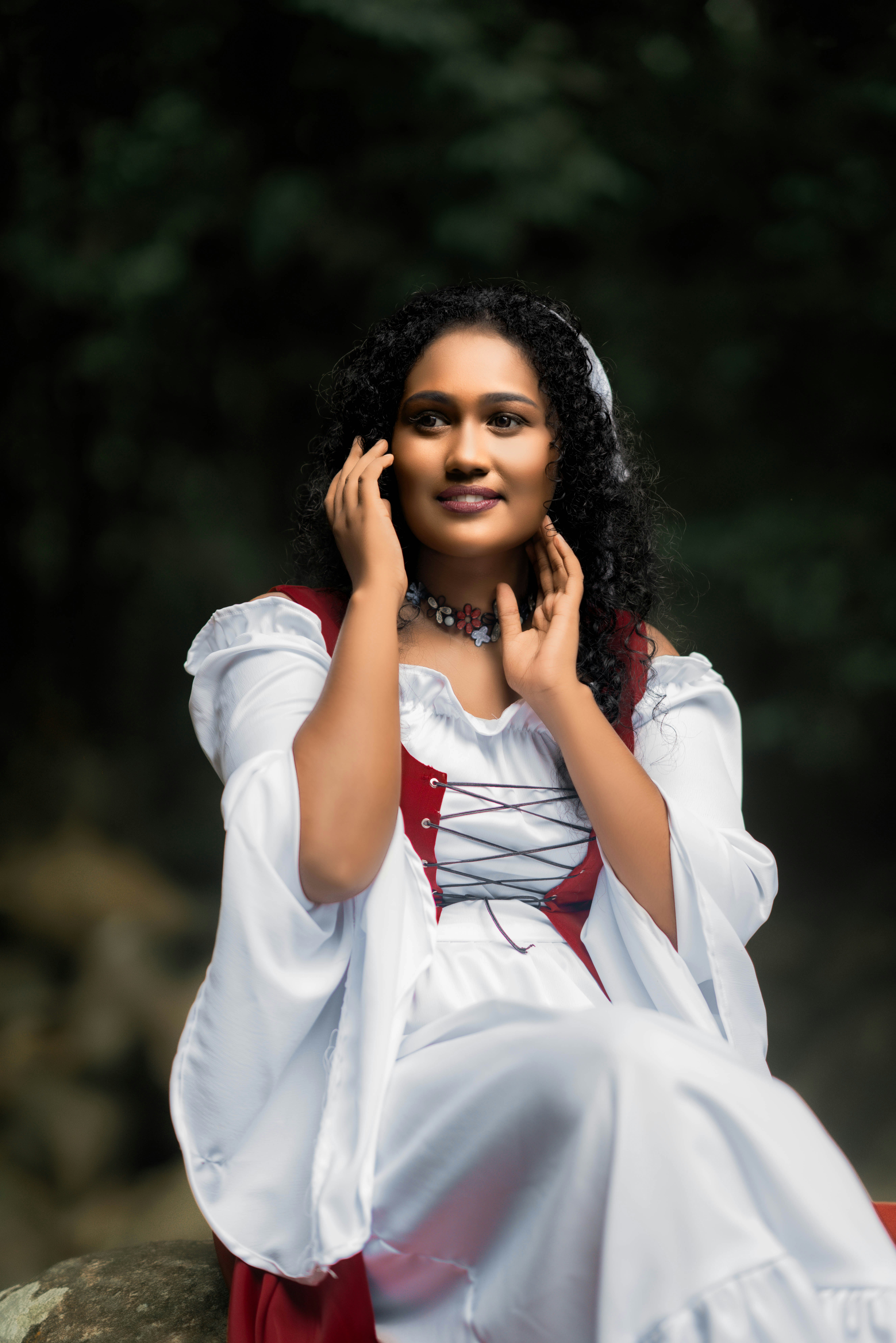 Regal Heritage: A Portrait in Traditional Attire Amid Quiet Nature