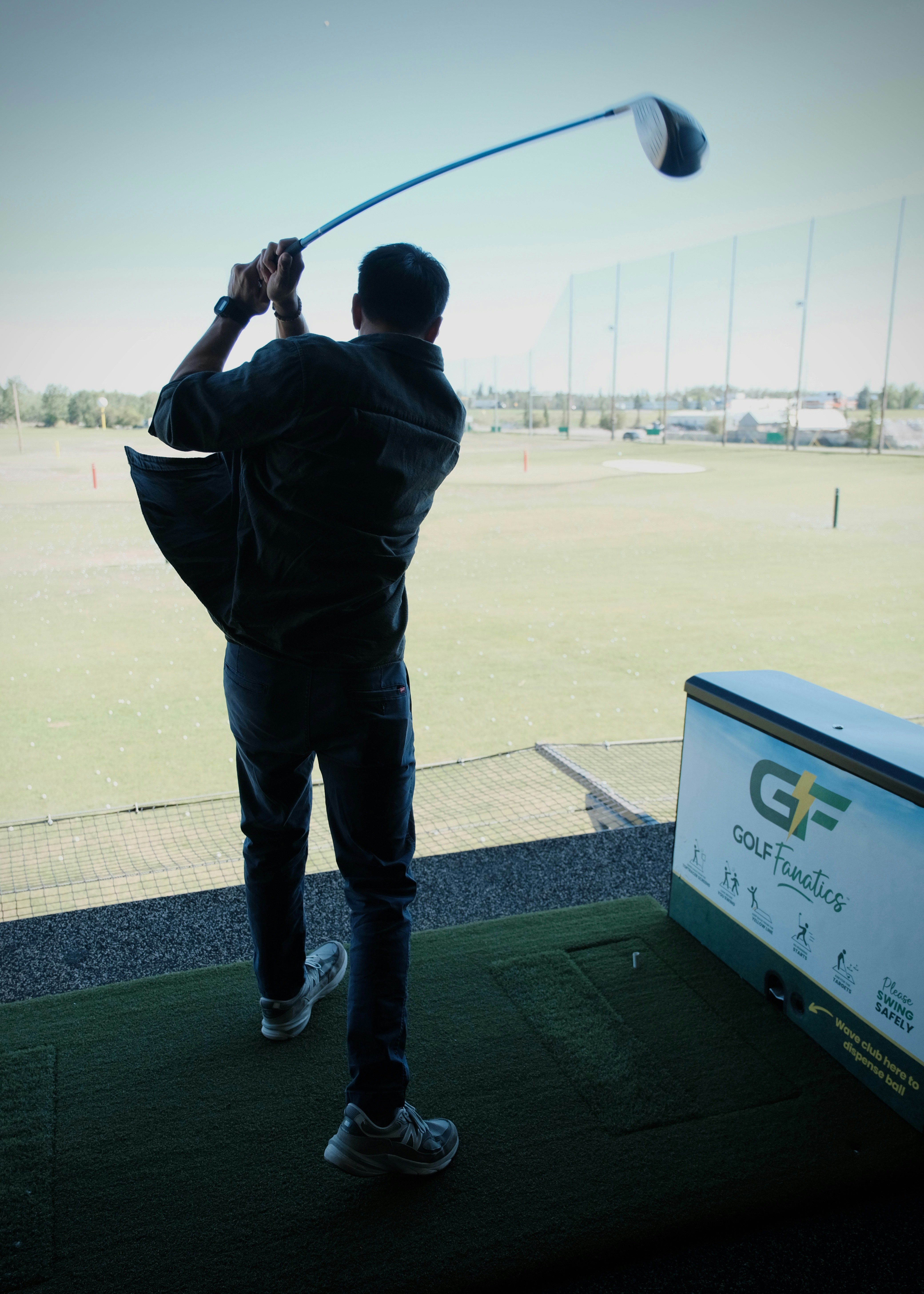 Swing Arc over the Driving Range: A Golf Enthusiast in Motion