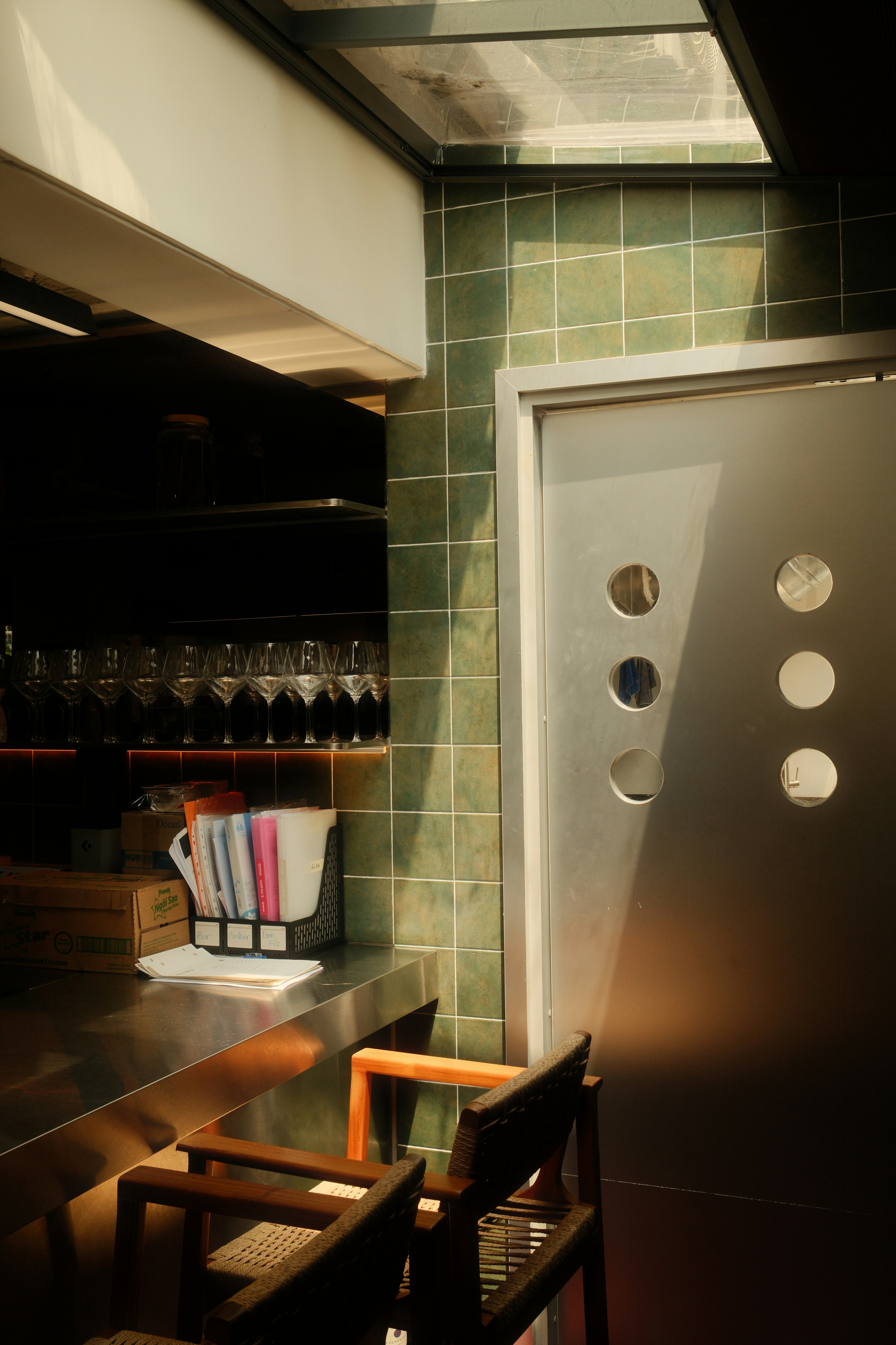 Doorway to the Bar: Sunlit Seating by Green Tile Walls