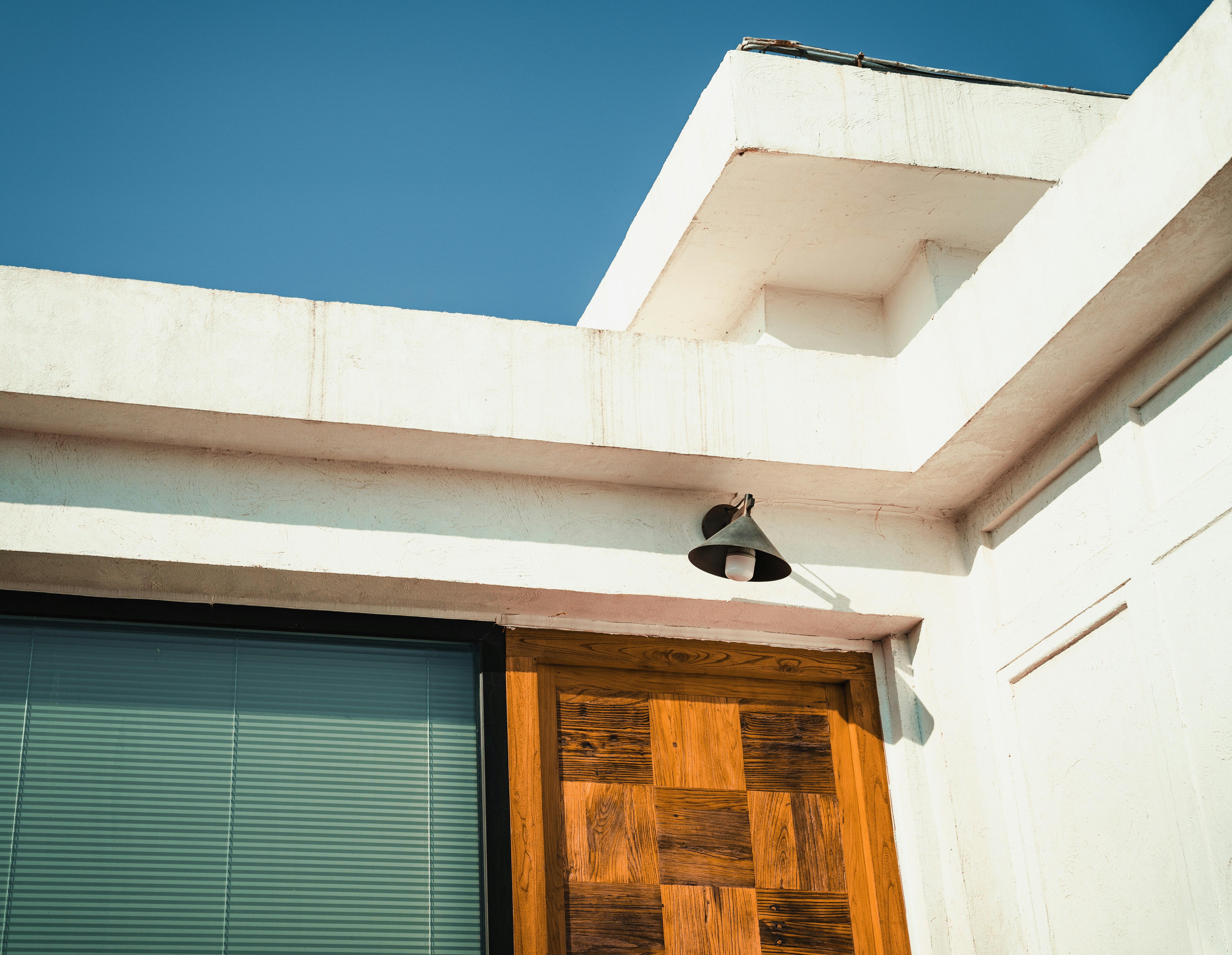 Concrete Geometry and Wood Portal Under a Clear Blue Sky