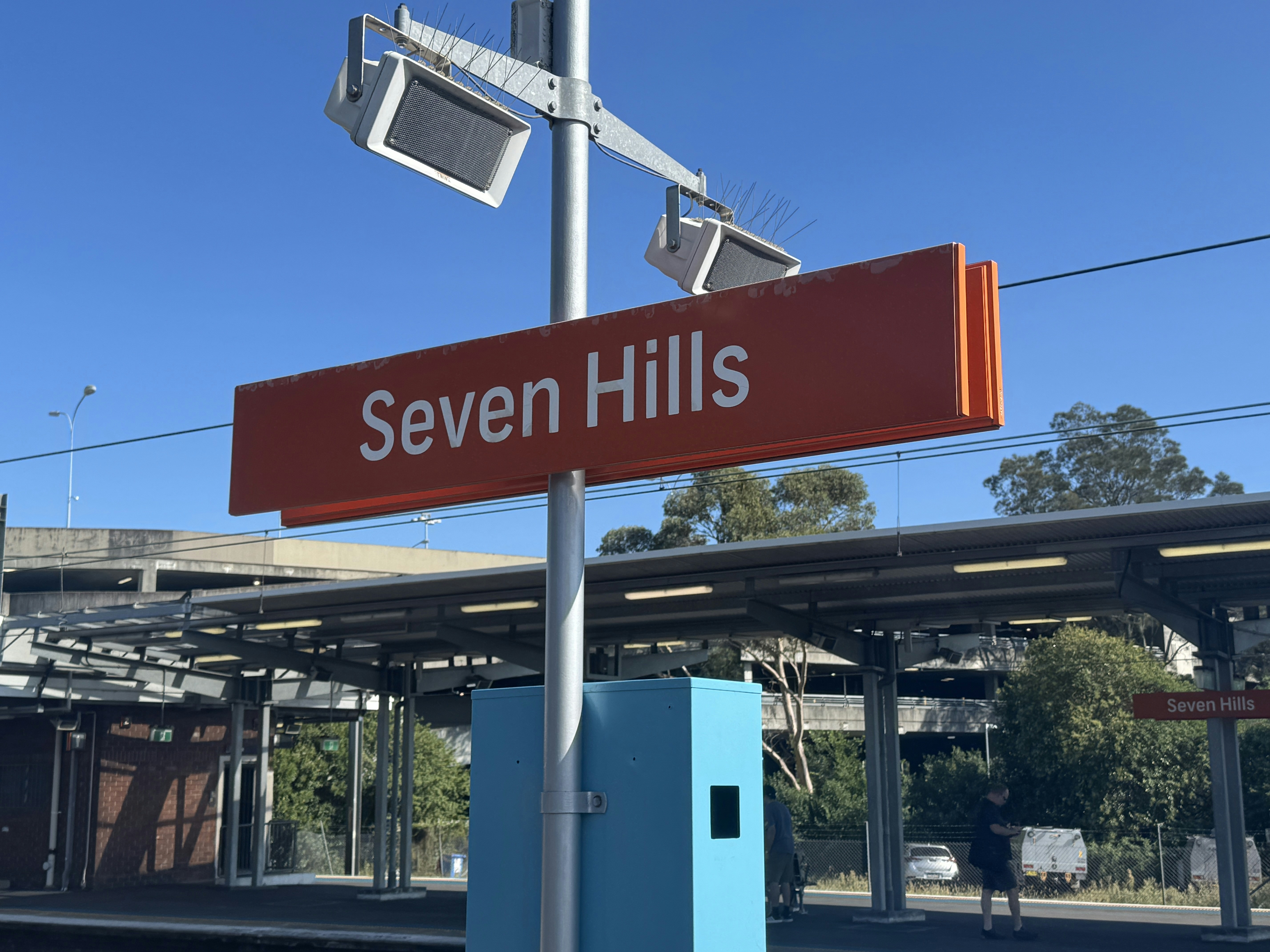 Seven Hills Station Signage Amid Elevated Transit Canopy