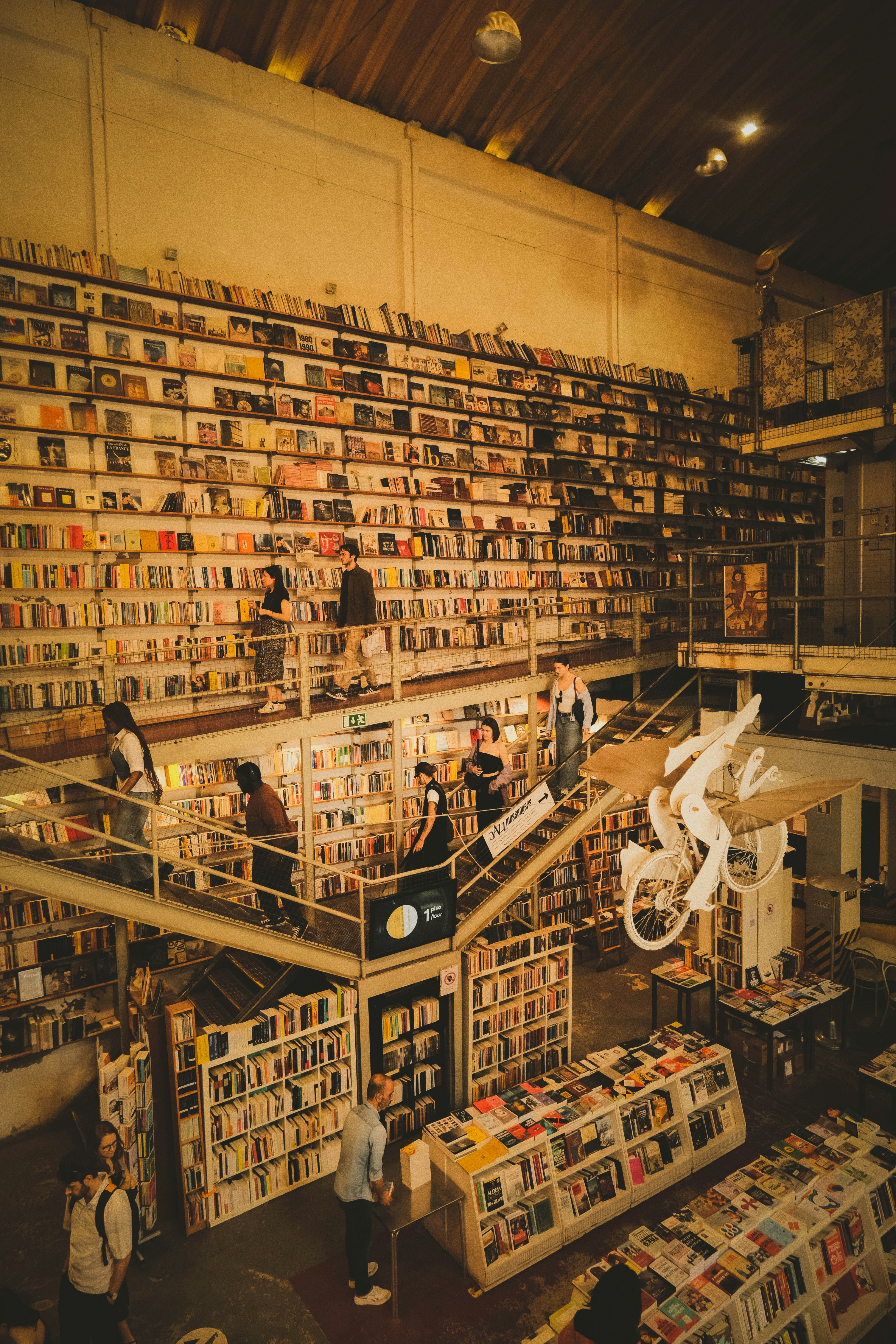A multi-level bookstore filled with books and people browsing.