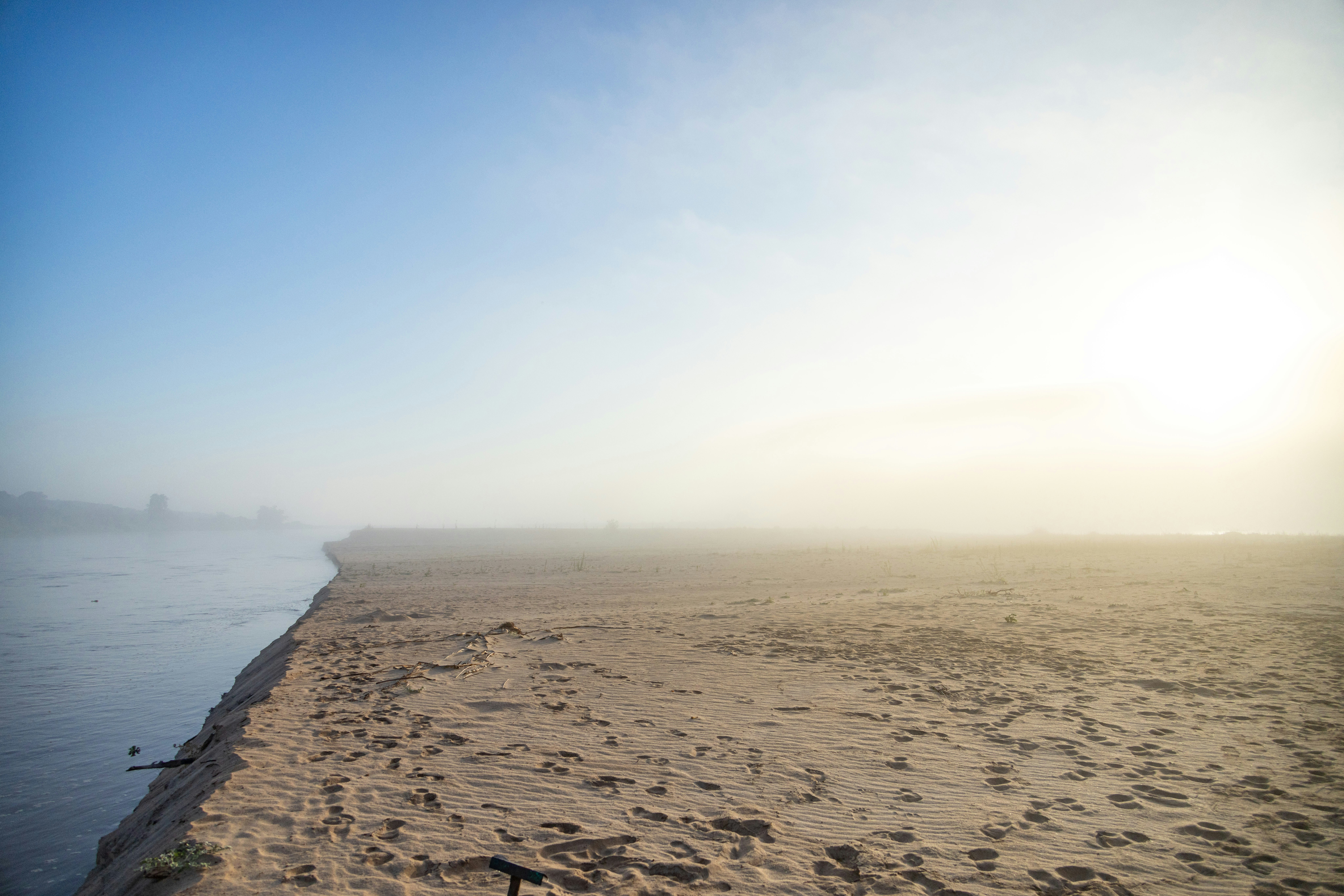 Deserted Shoreline at Dawn: A Quiet Convergence of Sand and Light