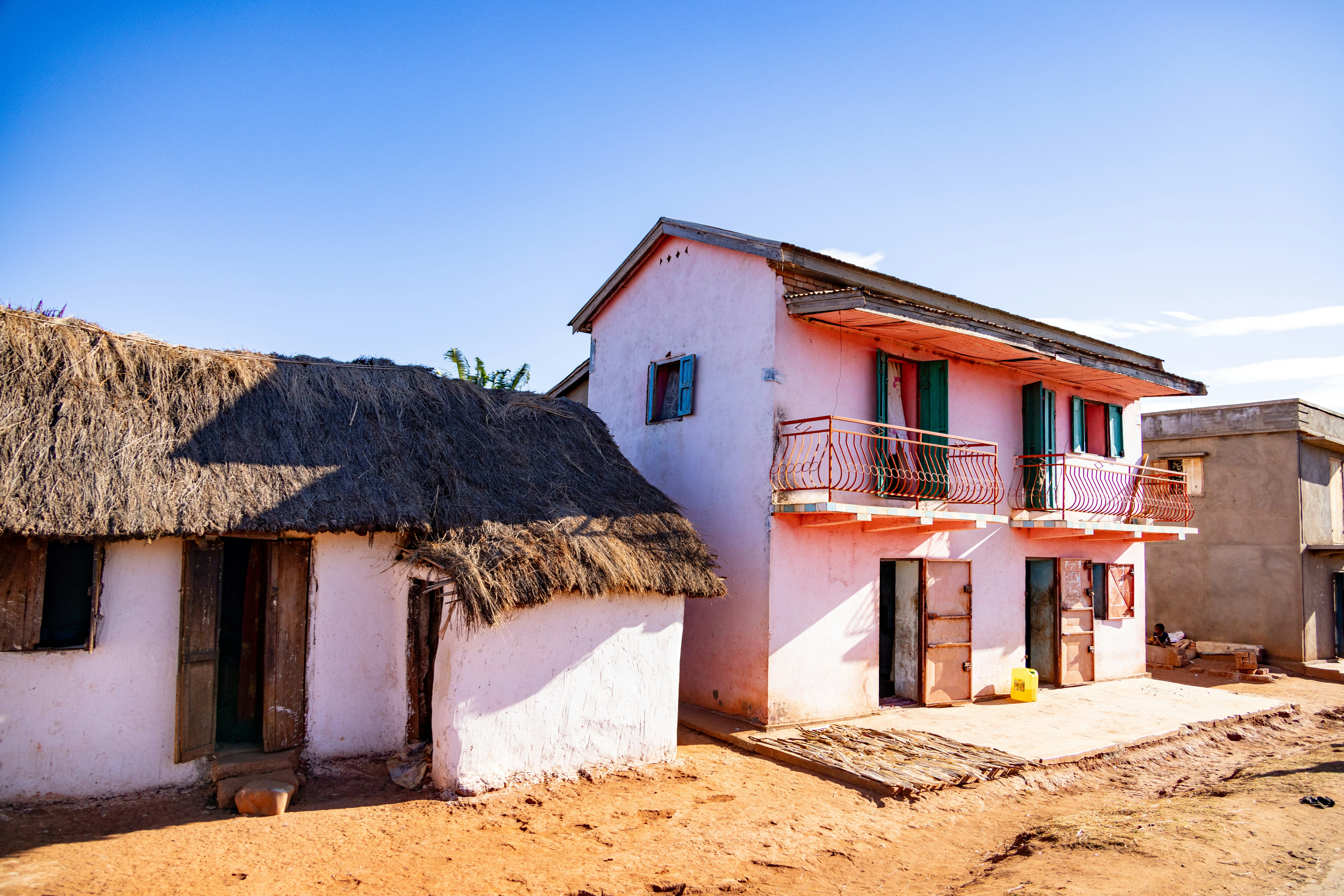 Sunlit Pink House Duo: A Quiet Coastal Street