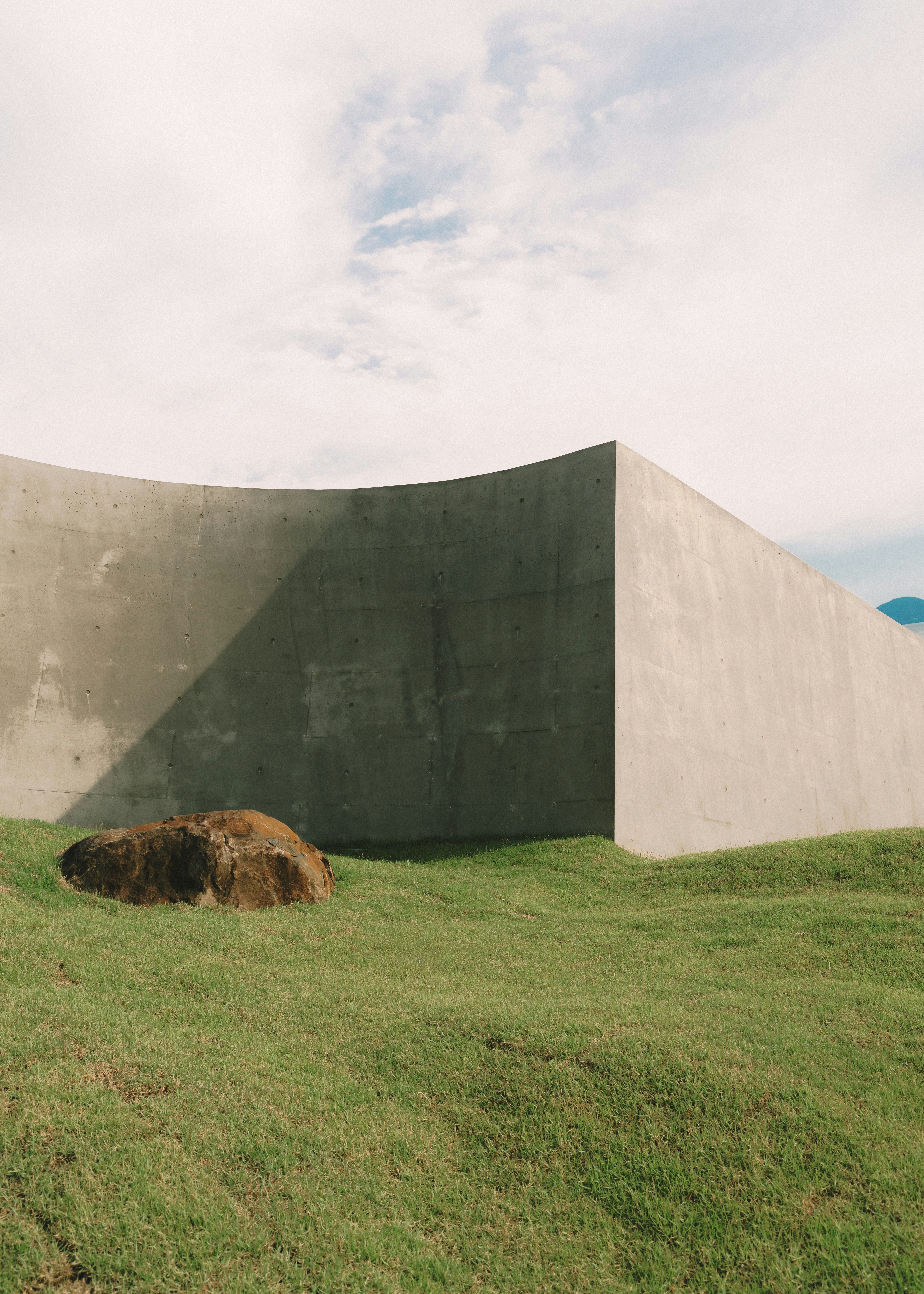 Concrete Wave: A Minimalist Sculpture of Light and Grass