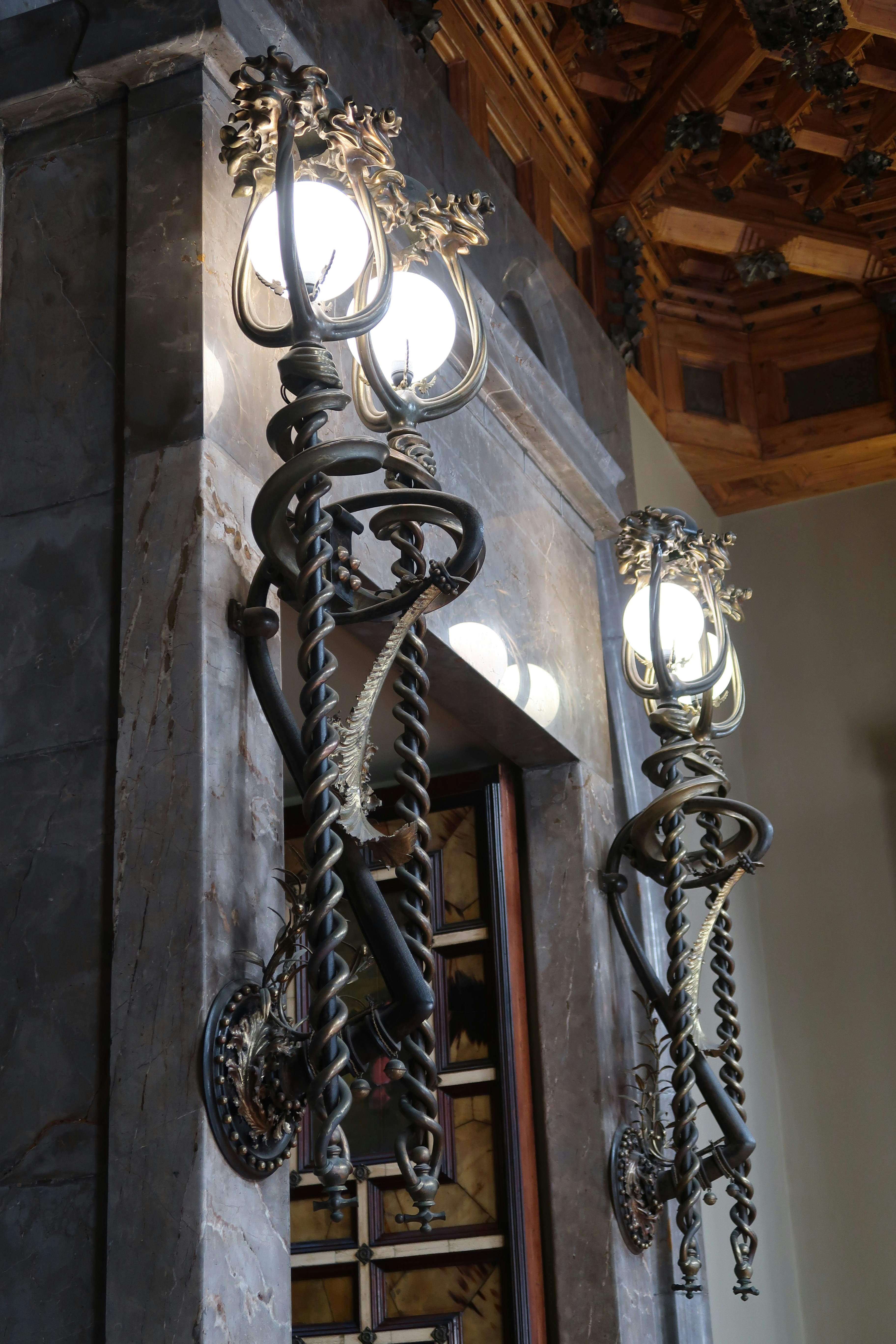 Ornate Street Lamps in a Marble Façade Hallway
