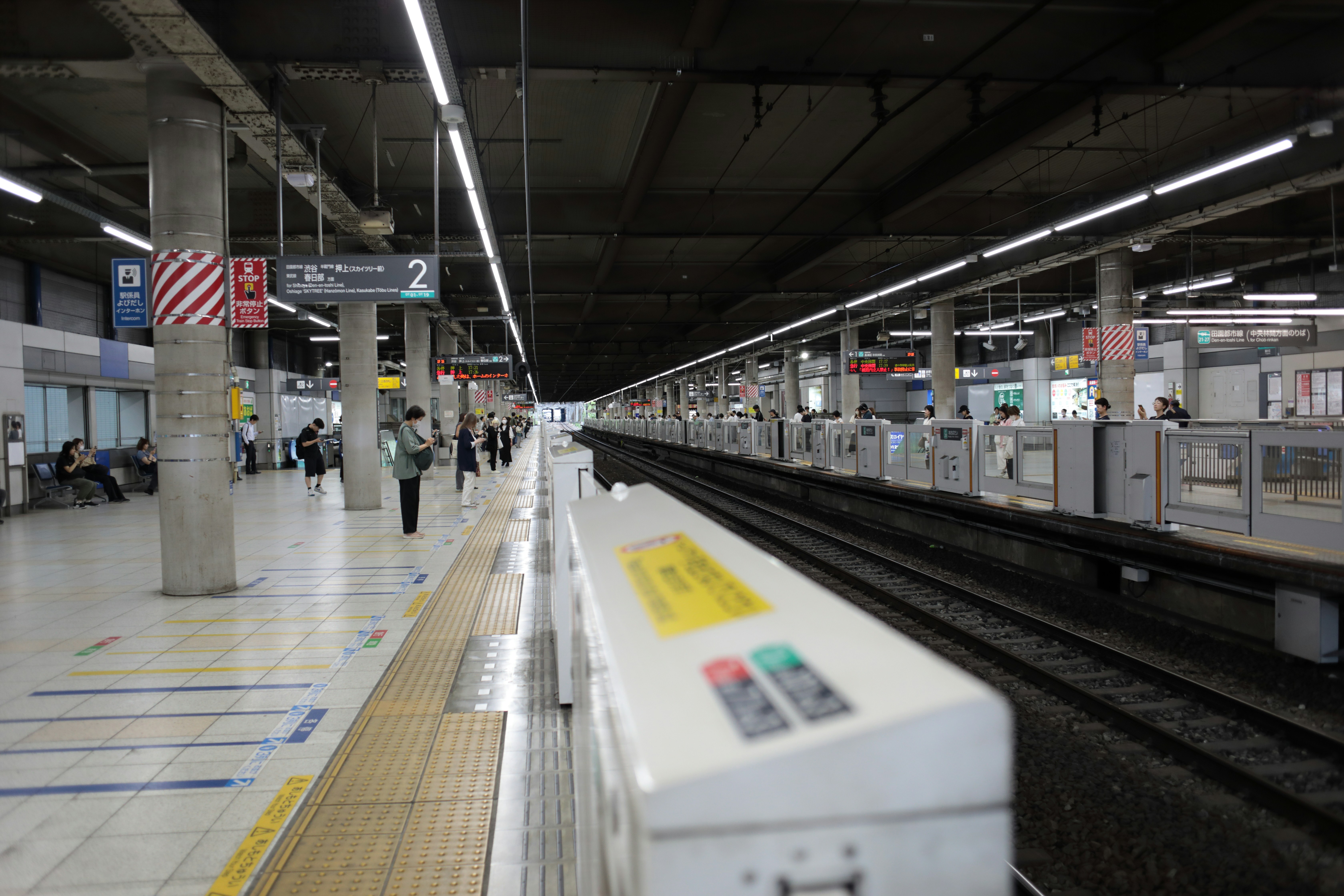 Midday Commute: A Quiet Moment on a Busy Tokyo-Style Platform