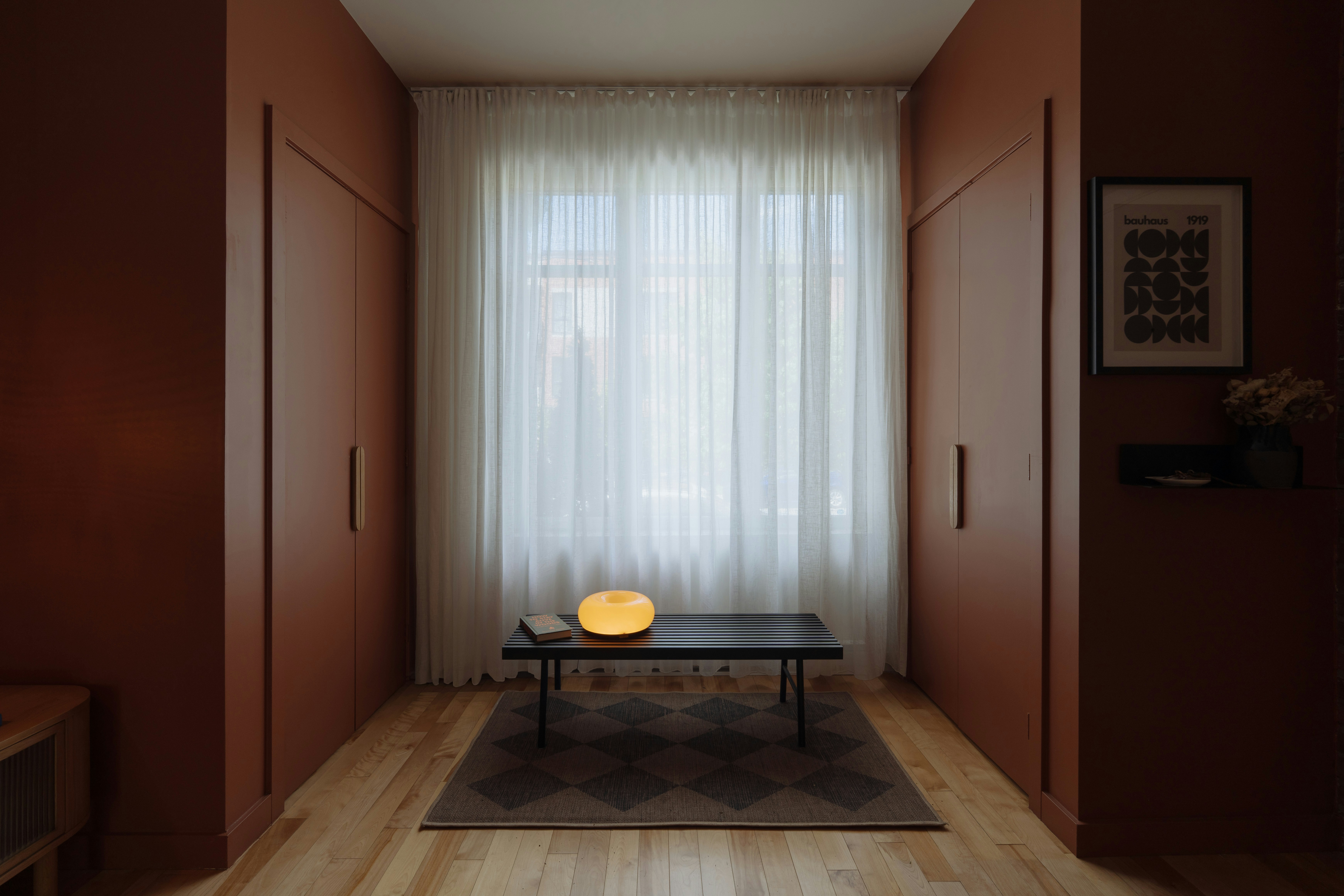 Minimalist Atrium: Light-Soaked Window Frame and Central Table