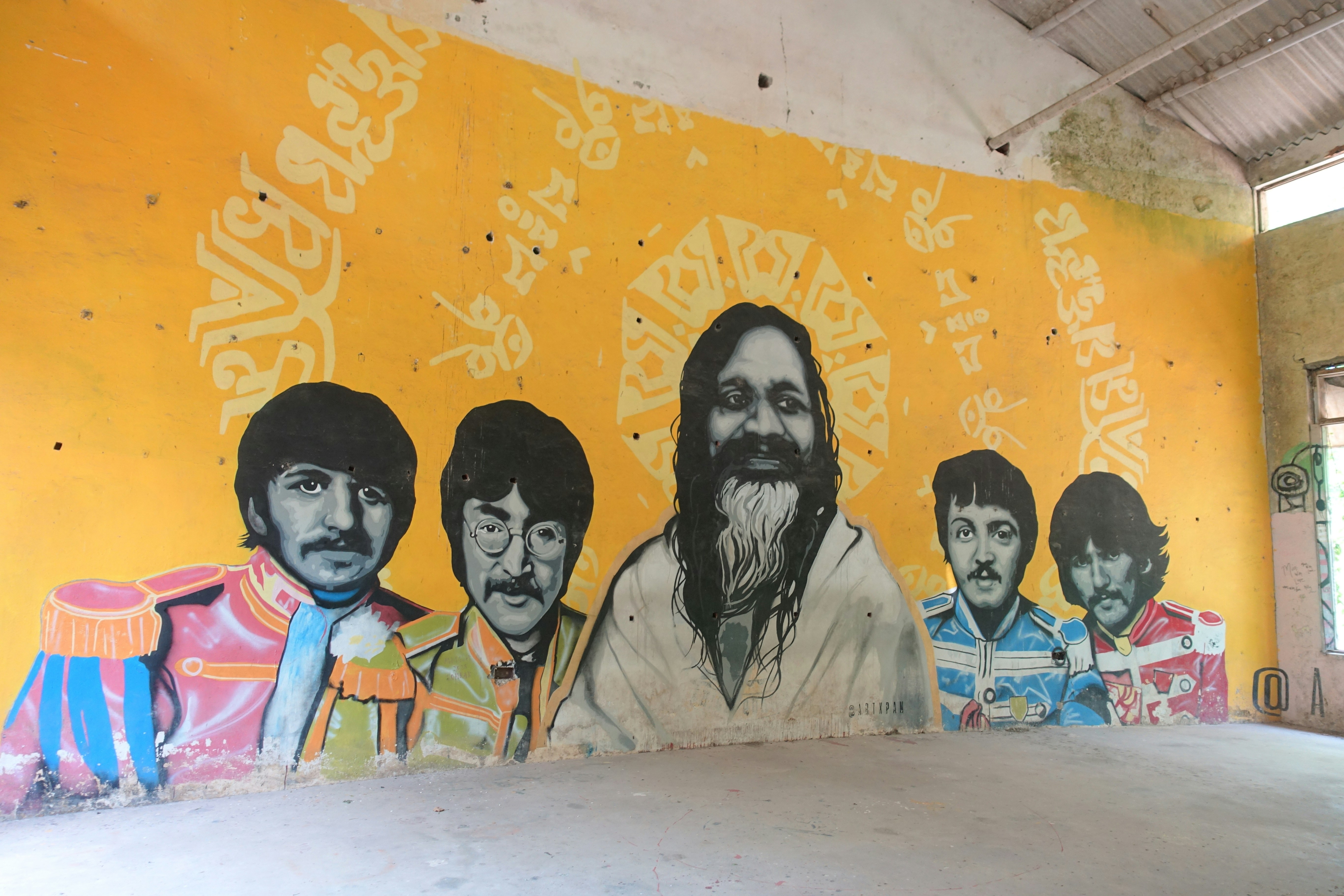 Bearded Sage in a Sunlit Alley of Colorful Portraits