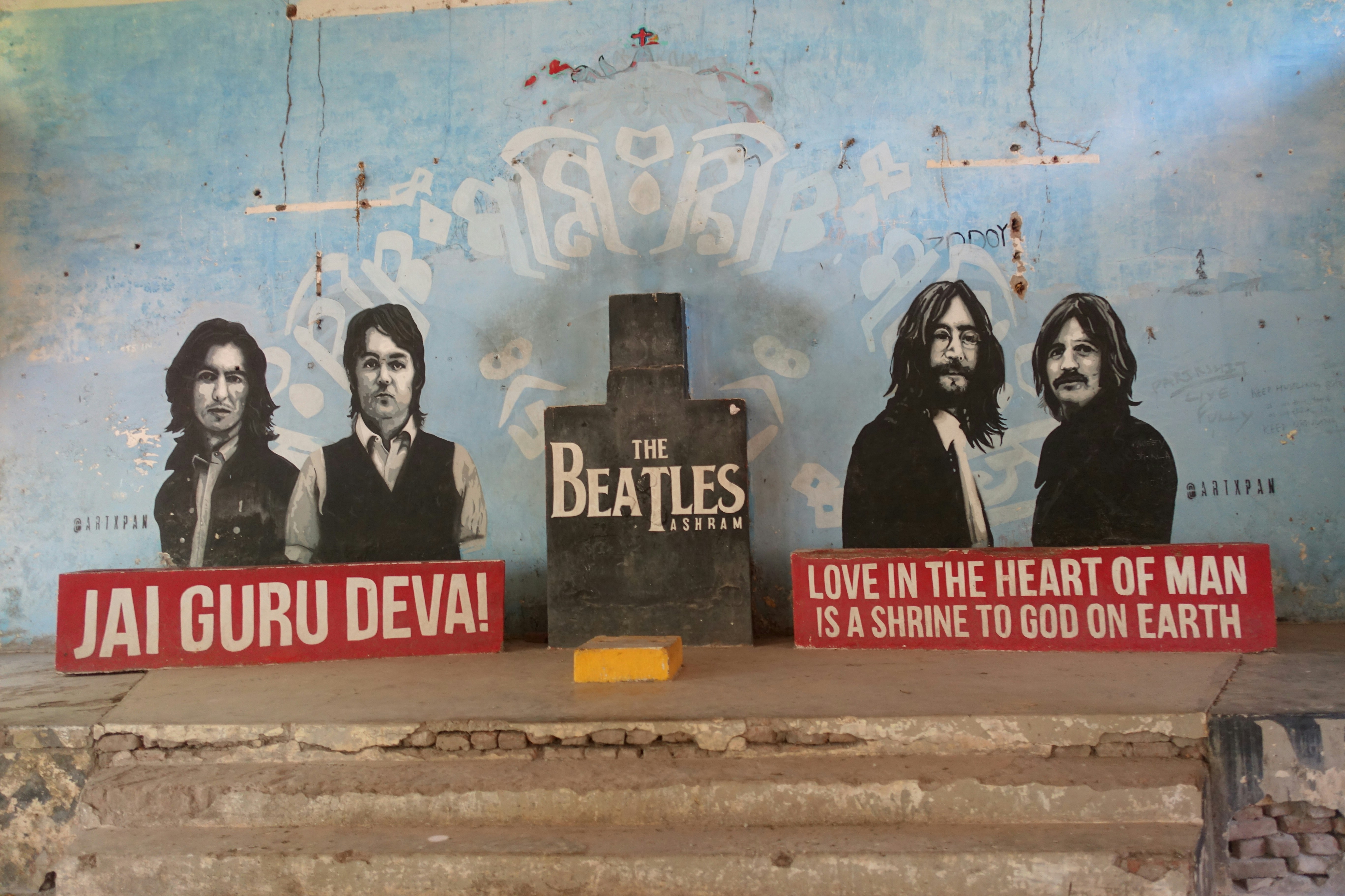 The Beatles Shrine: Murals Framing a Concrete Obelisk