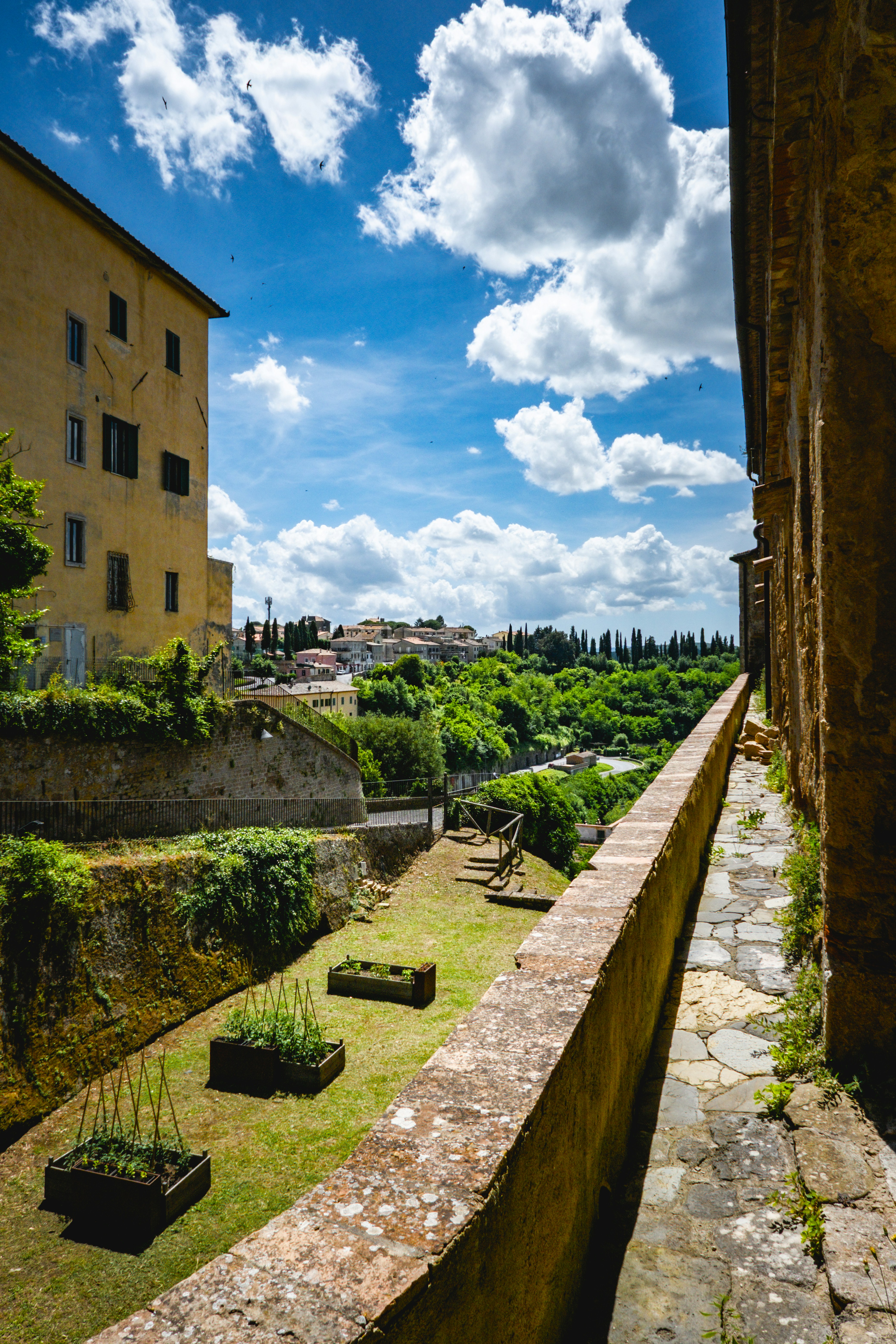 Ridge Walkway Between Aged Walls Overlooking a Verdant Valley