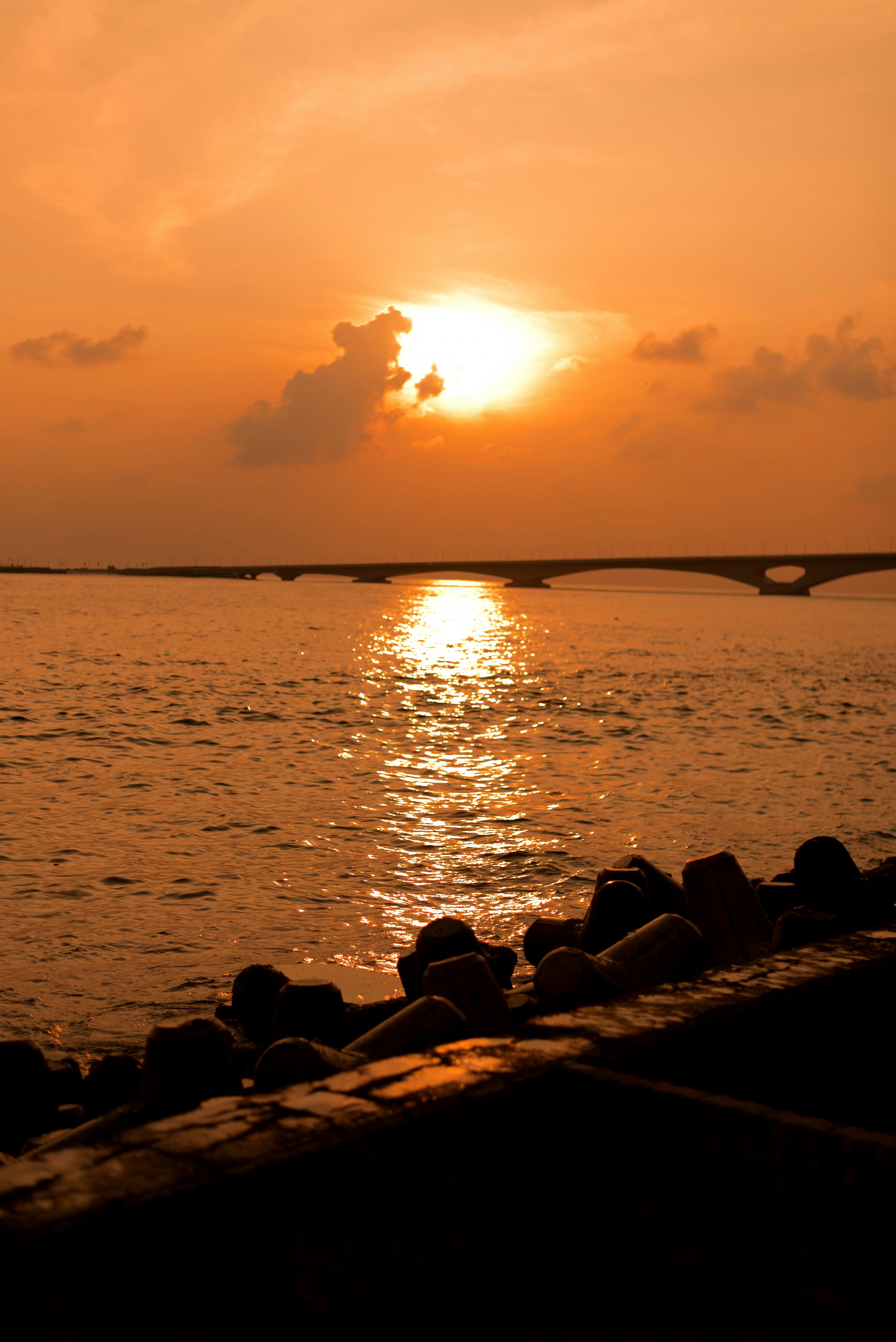 Sunlit Bridge Over a Quiet Sea at Dusk