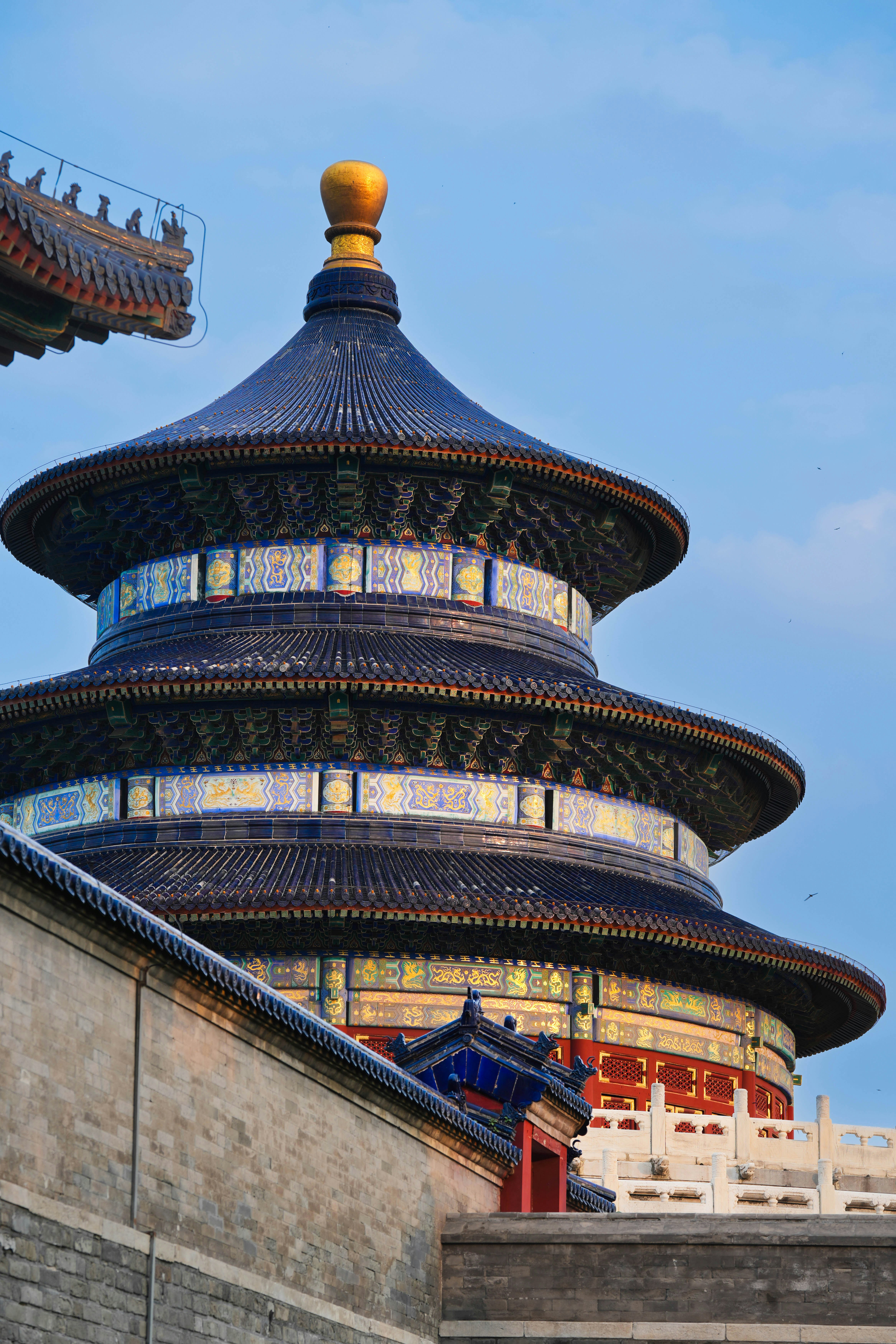 Temple of heaven's blue tiered roof and golden finial.