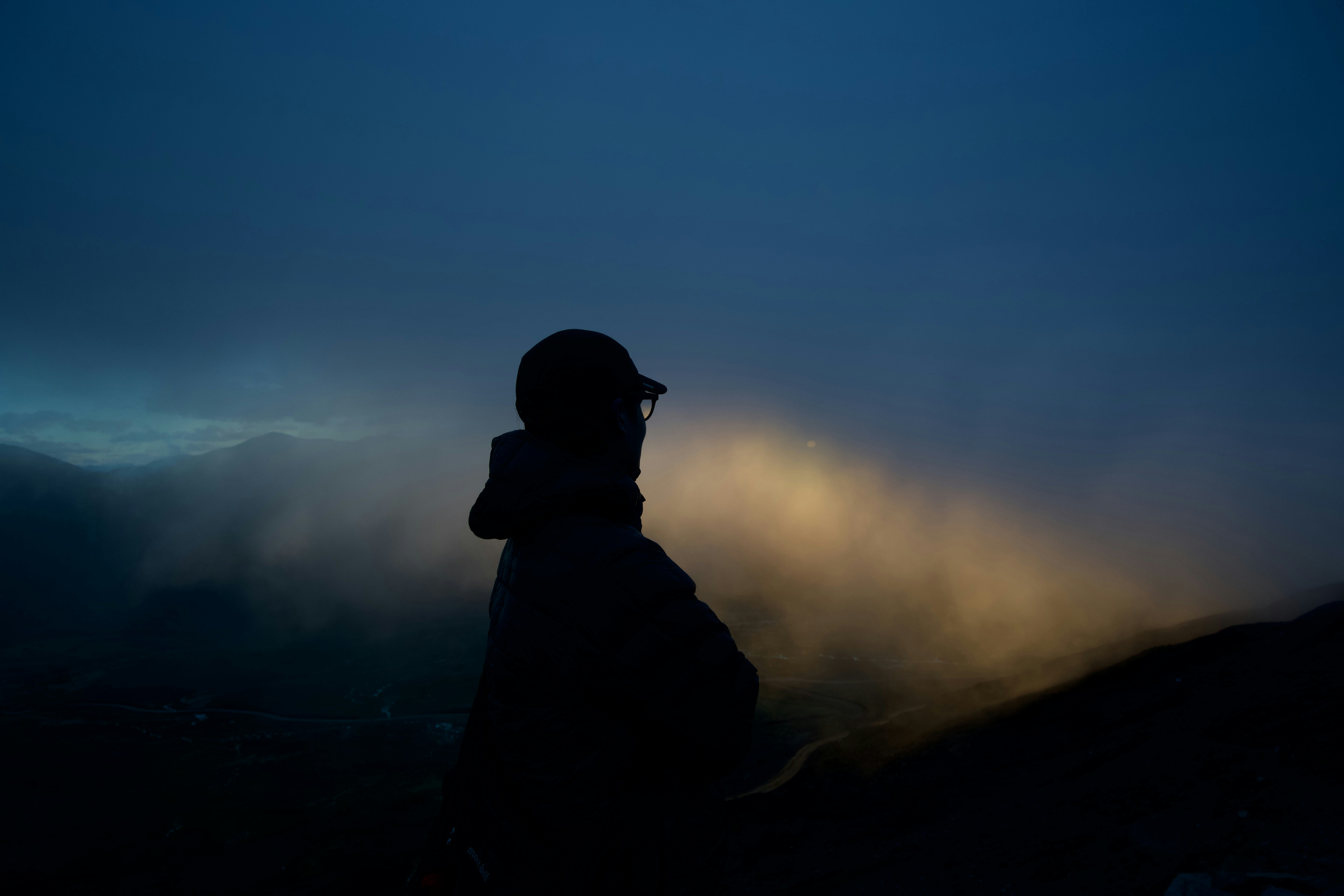 Silhouette Against Misty Dusk: A Quiet Summit Moment
