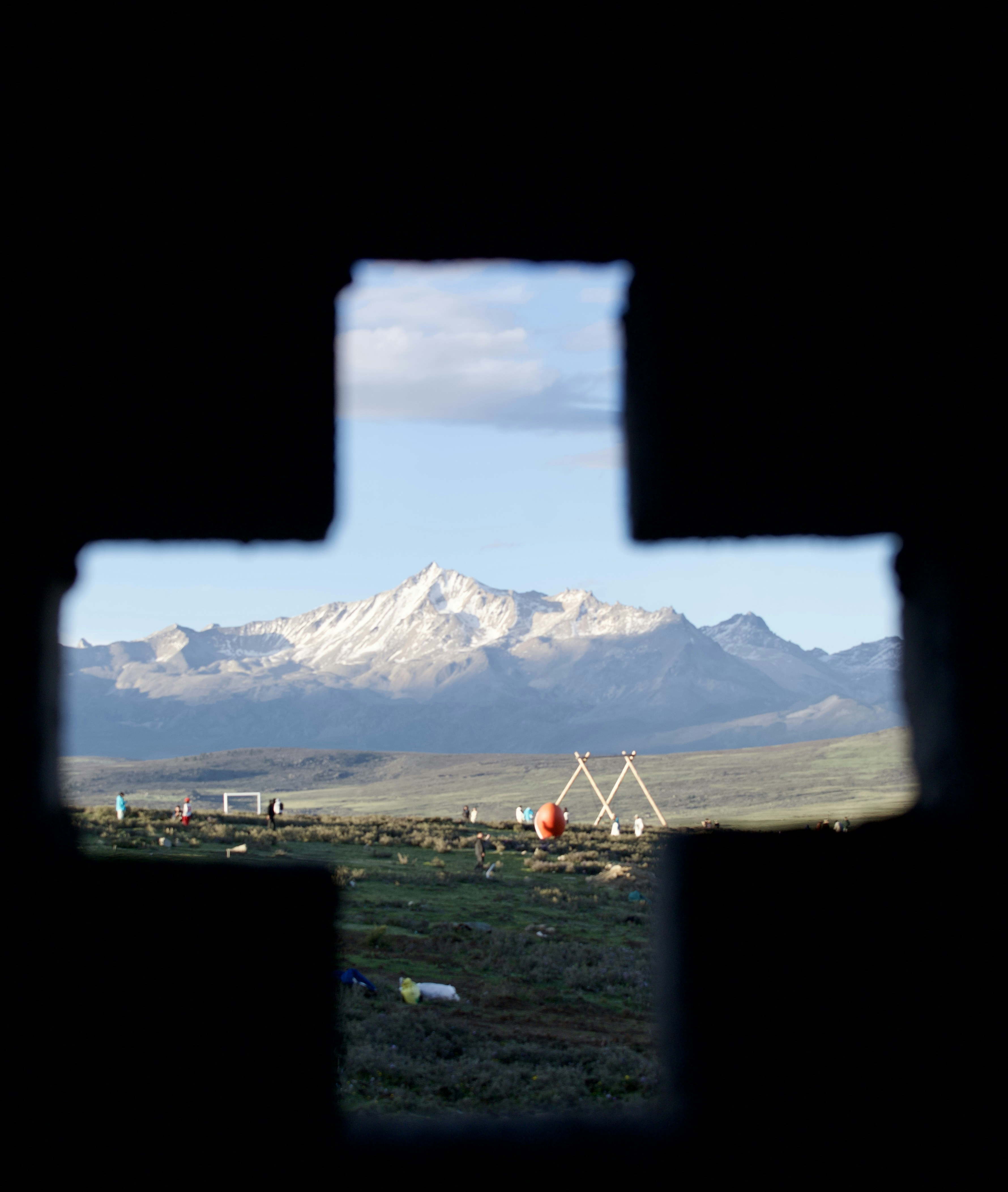 Snowy Peaks framed by a primitive window